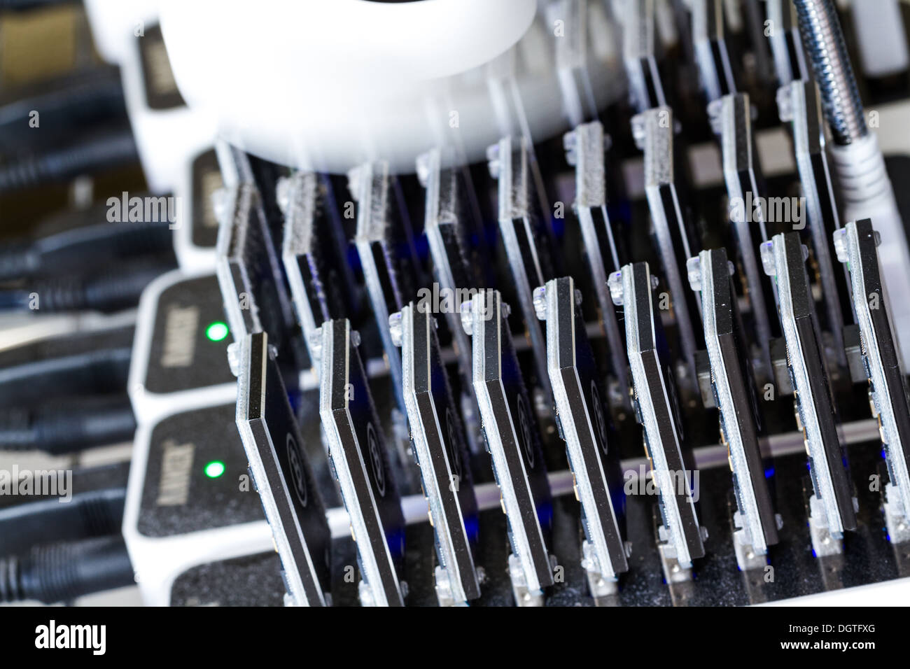 Bitcoin mining USB devices in a row with small fans Stock Photo - Alamy