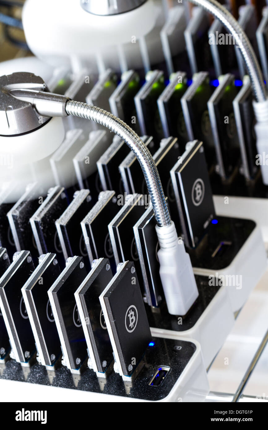 Bitcoin mining USB devices in a row with small fans Stock Photo - Alamy