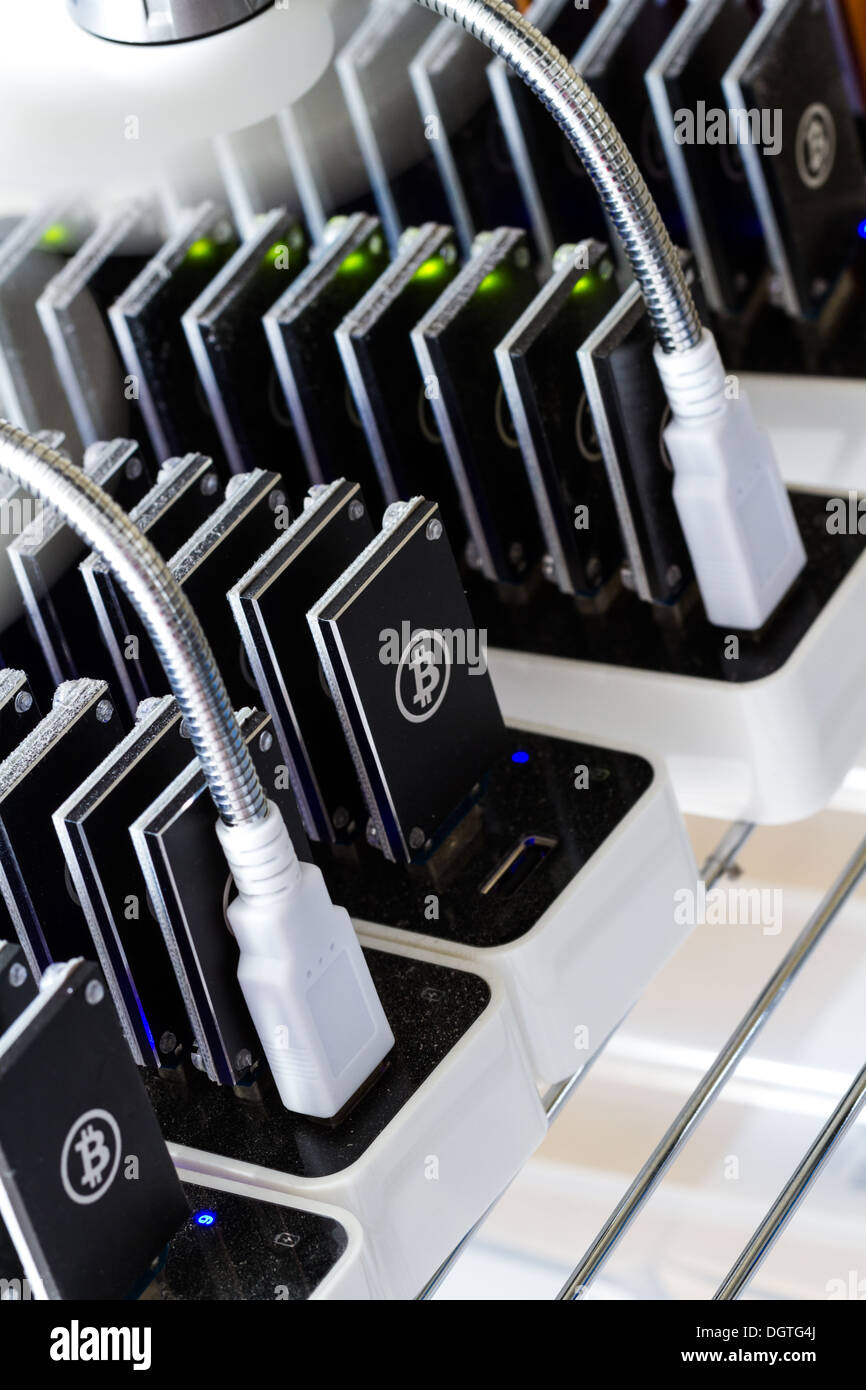 Bitcoin mining USB devices in a row with small fans Stock Photo - Alamy