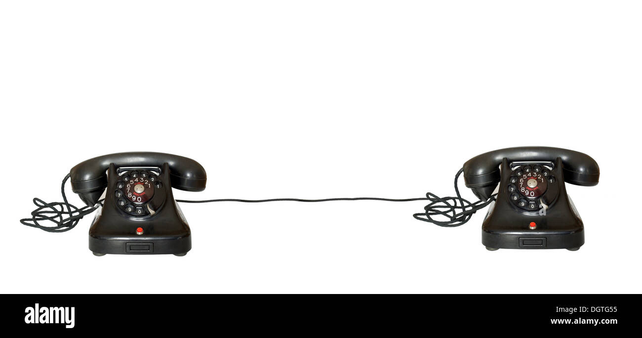 two telephones joint on white background with cable Stock Photo - Alamy