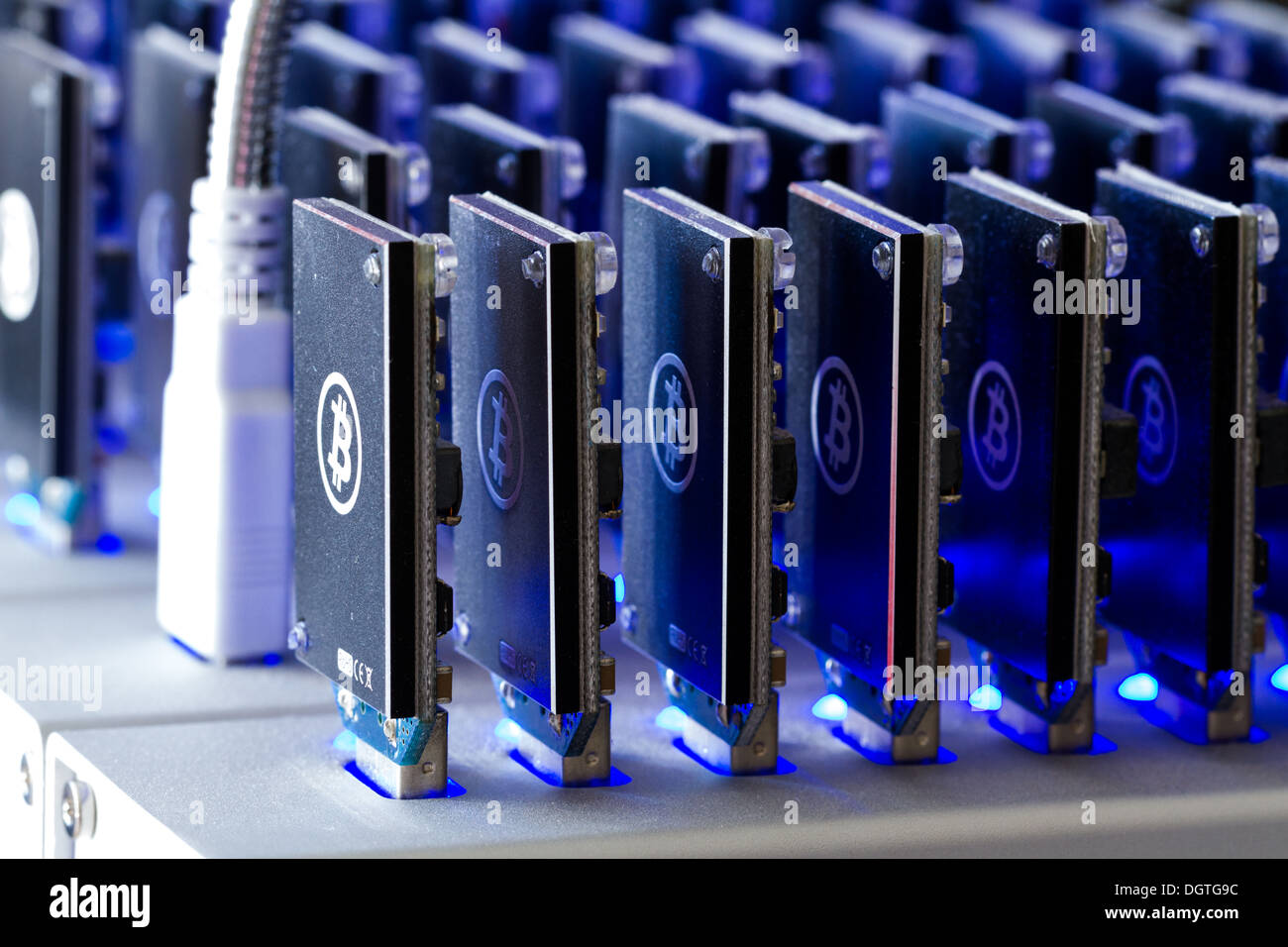 Bitcoin mining USB devices in a row with small fans Stock Photo - Alamy