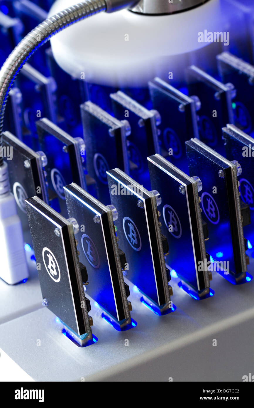 Bitcoin mining USB devices in a row with small fans Stock Photo - Alamy