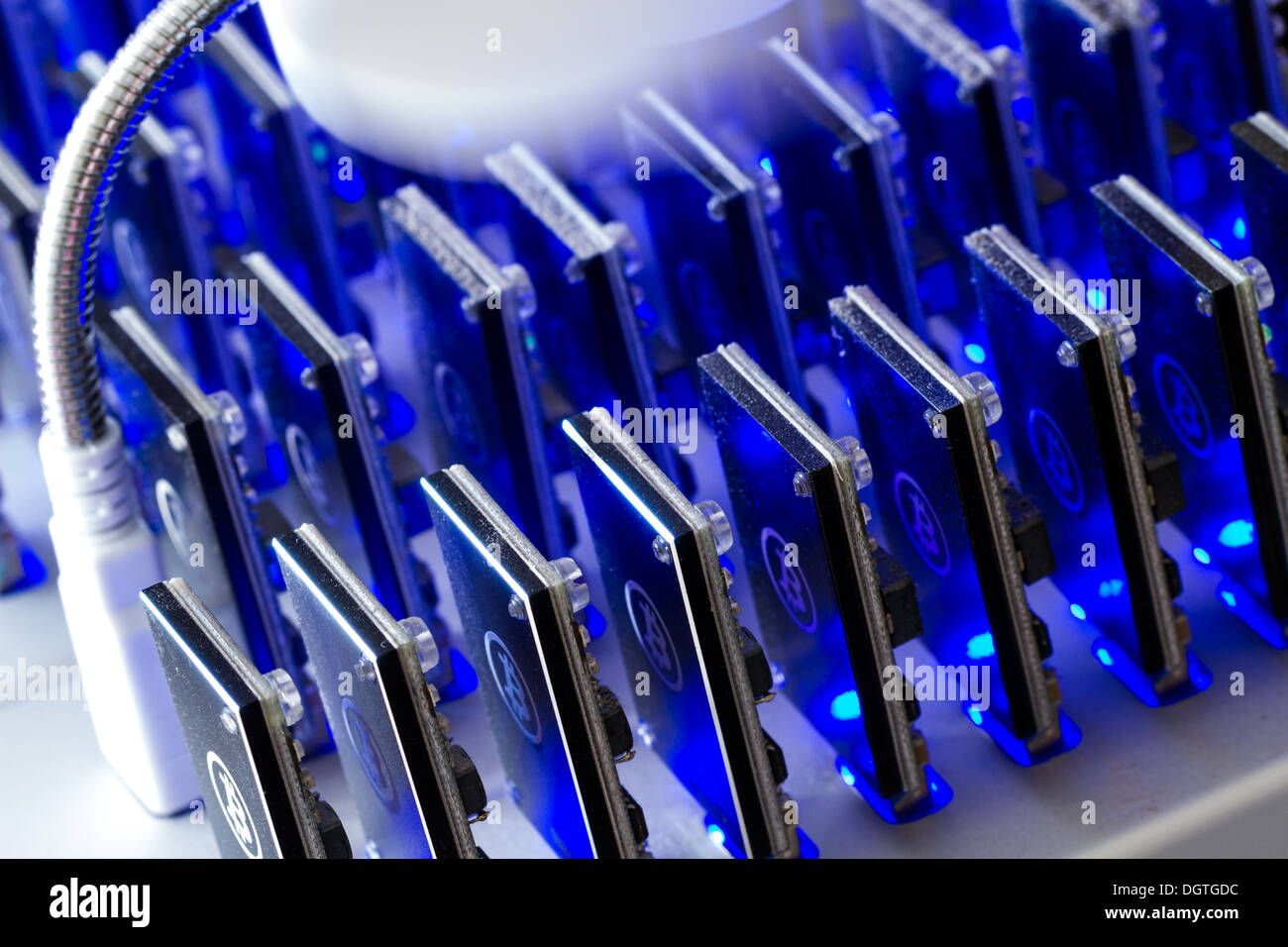 Bitcoin mining USB devices in a row with small fans Stock Photo - Alamy