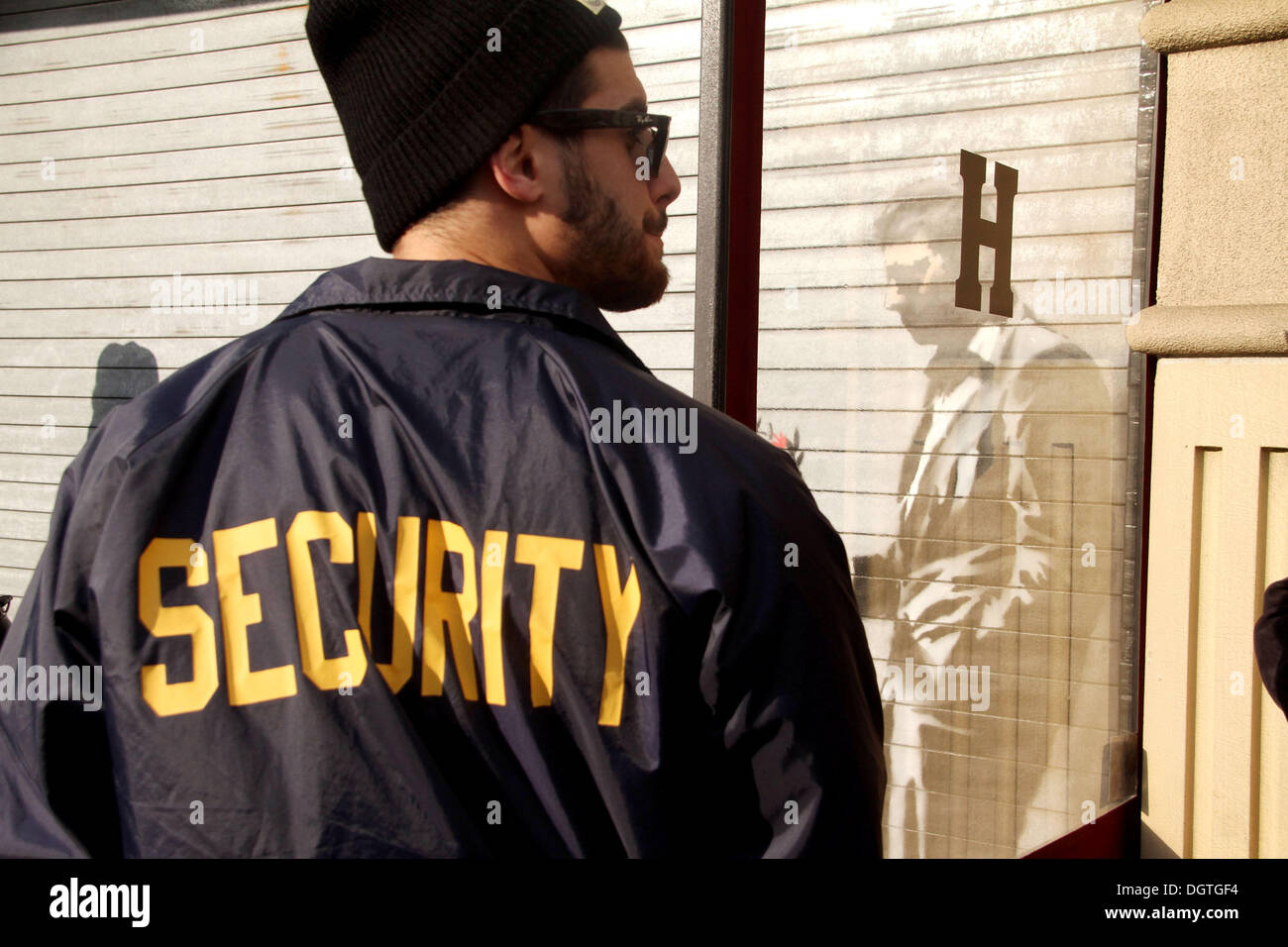New York, New York, USA. 24th Oct, 2013. A security guard protects ...