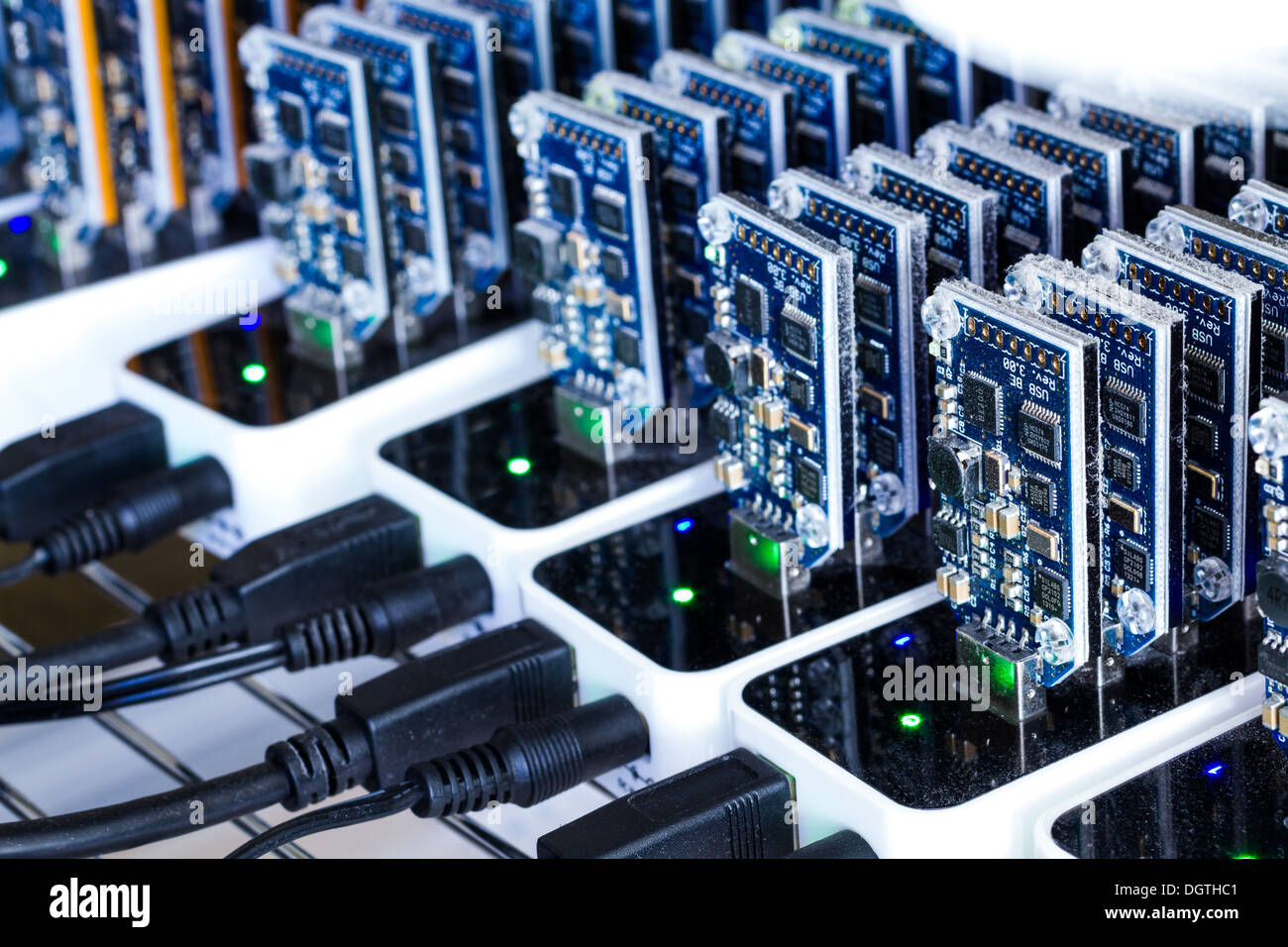 Bitcoin mining USB devices in a row with small fans Stock Photo - Alamy