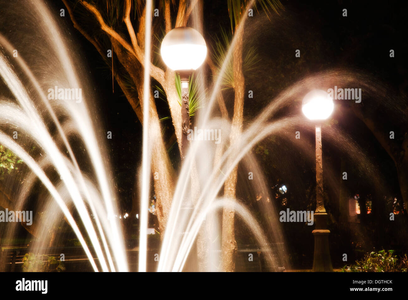 A radiant water fountain lights the darkness Stock Photo - Alamy