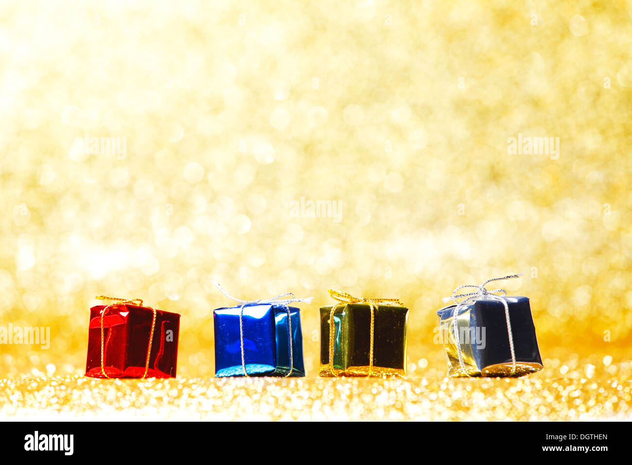 Colorful gift boxes on glitter golden background Stock Photo - Alamy