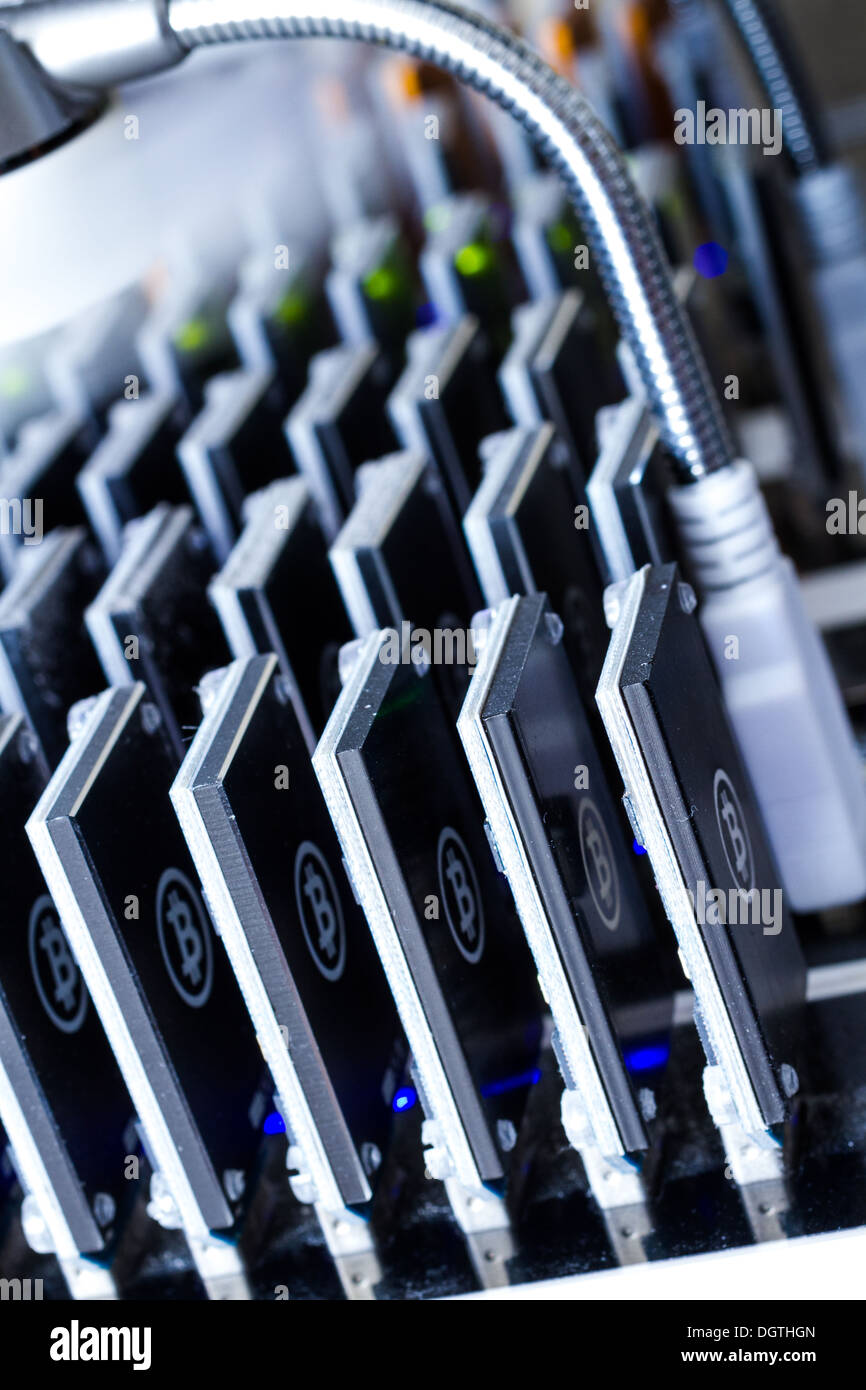 Bitcoin mining USB devices in a row with small fans Stock Photo - Alamy