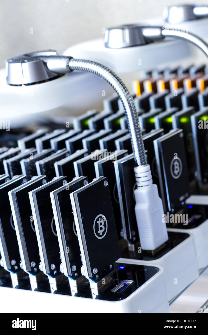 Bitcoin mining USB devices in a row with small fans Stock Photo - Alamy