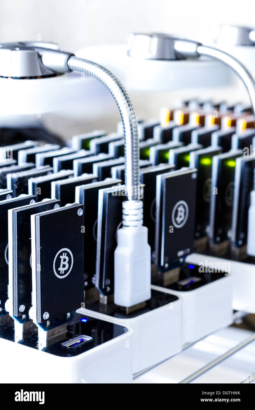 Bitcoin mining USB devices in a row with small fans Stock Photo - Alamy