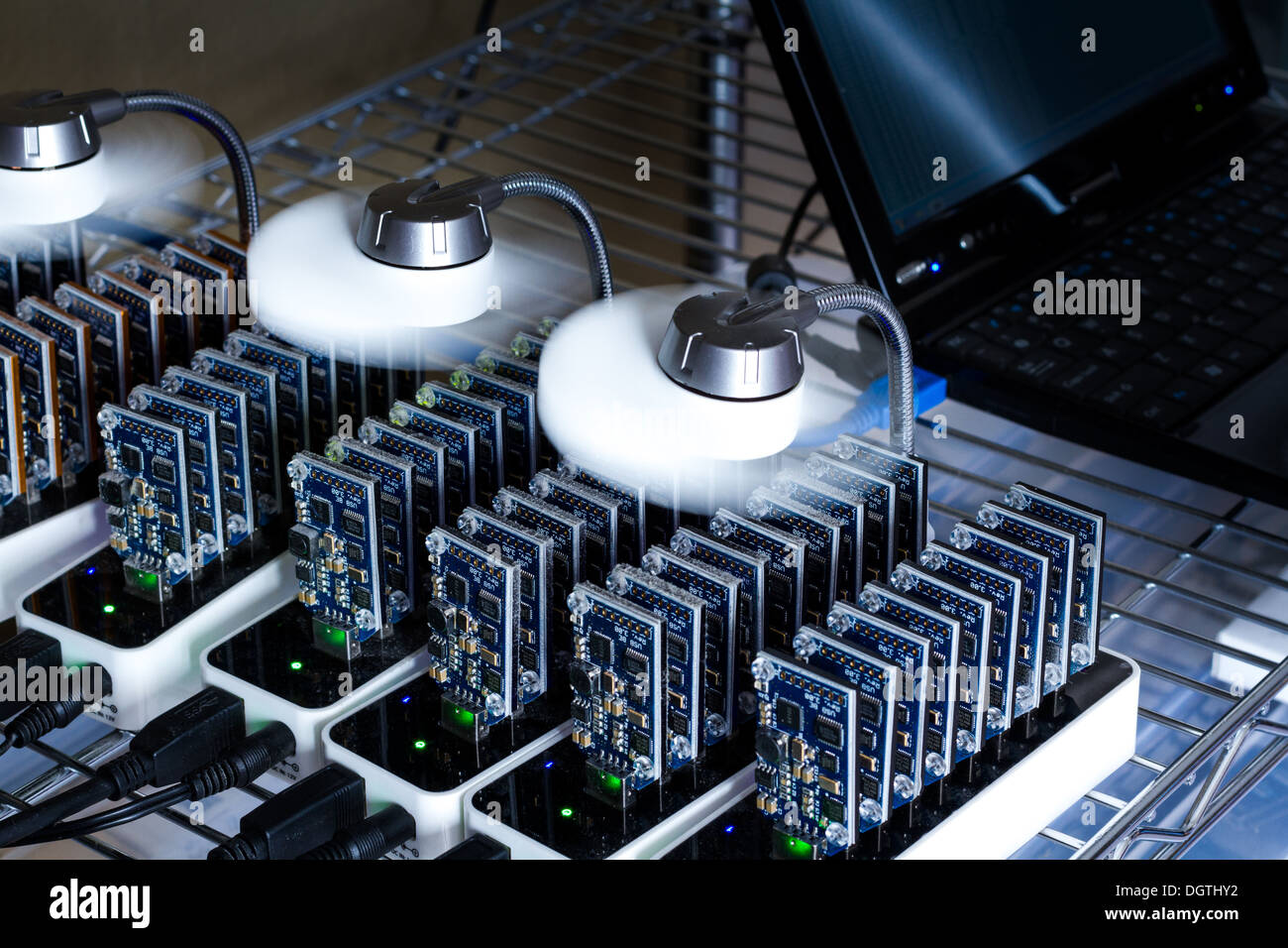 Bitcoin mining USB devices in a row with small fans Stock Photo - Alamy