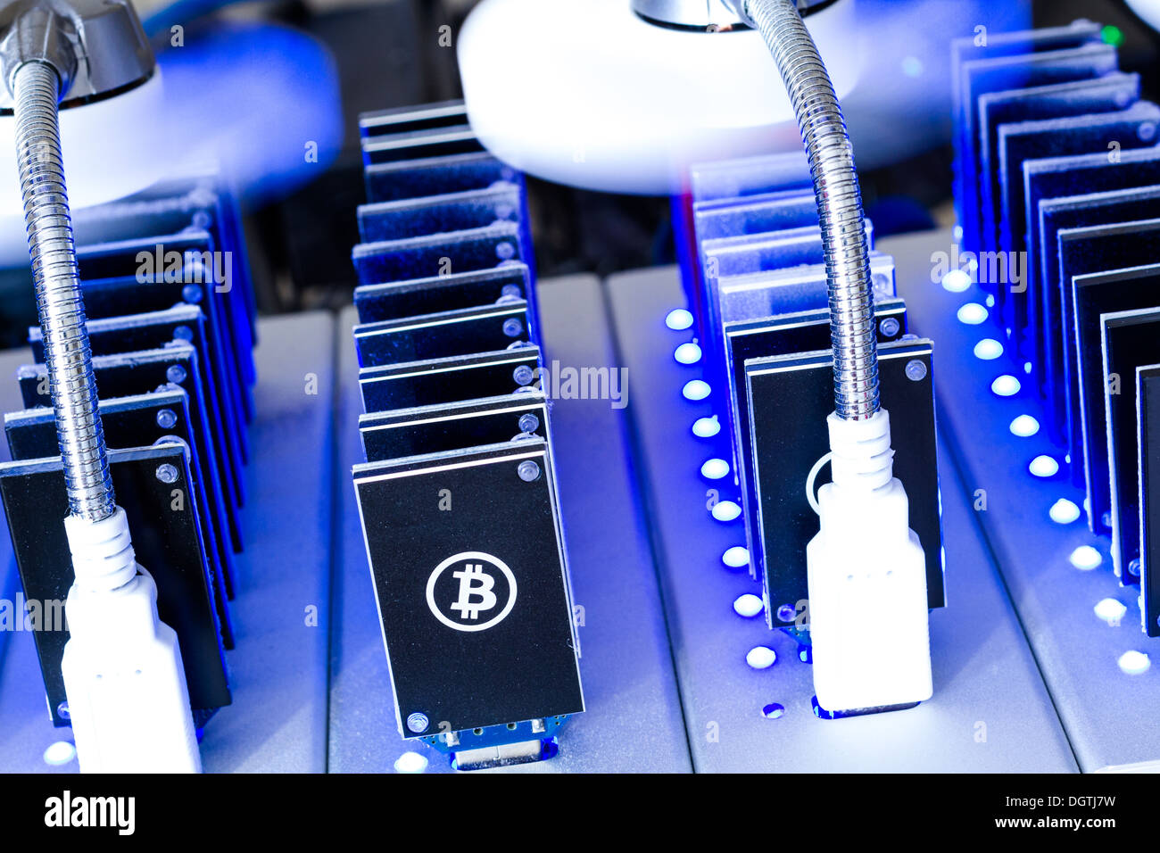Bitcoin mining USB devices in a row with small fans Stock Photo - Alamy