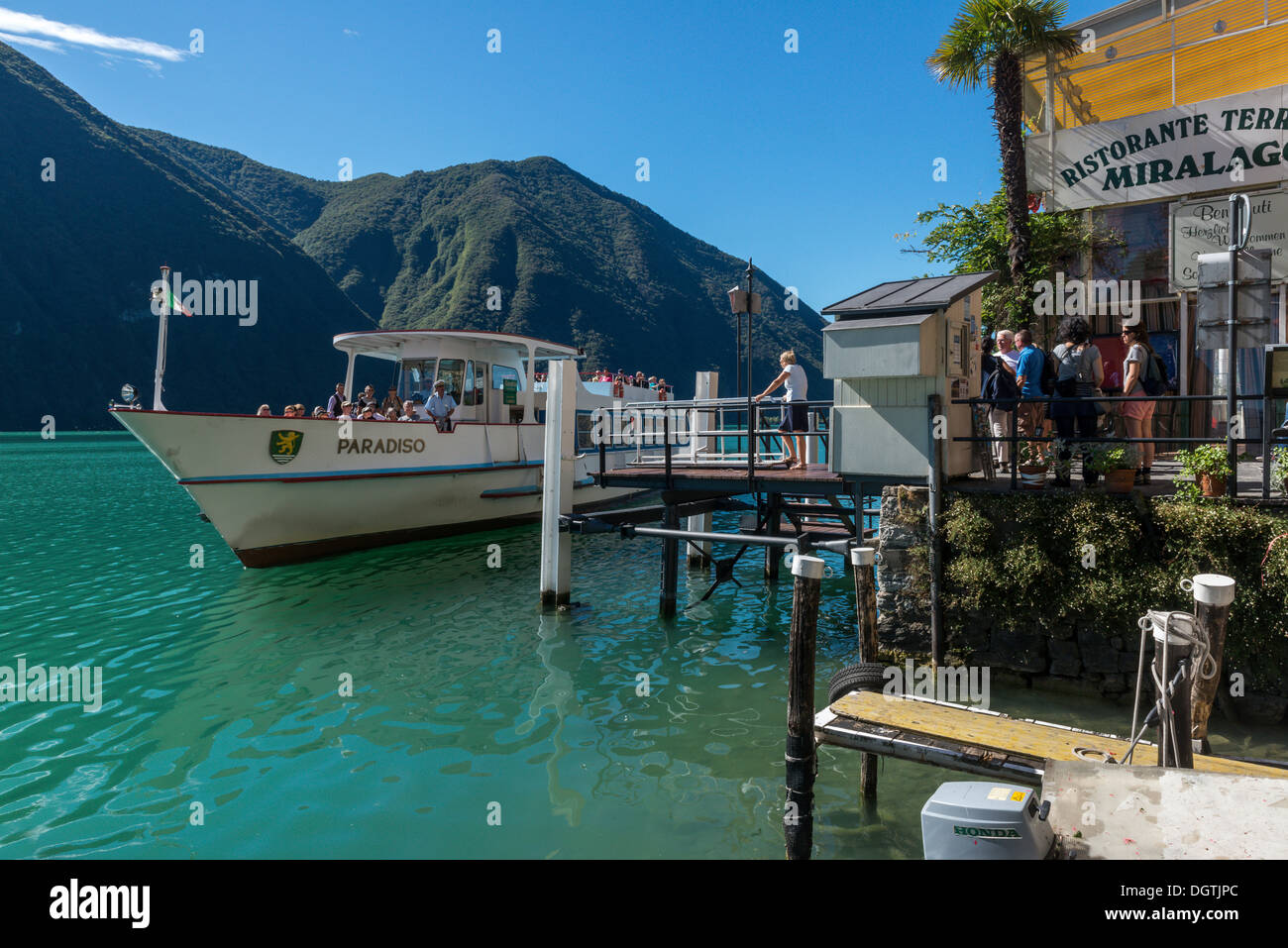 Passenger ferry boat arriving at the village of Gandria, Lake Lugano ...