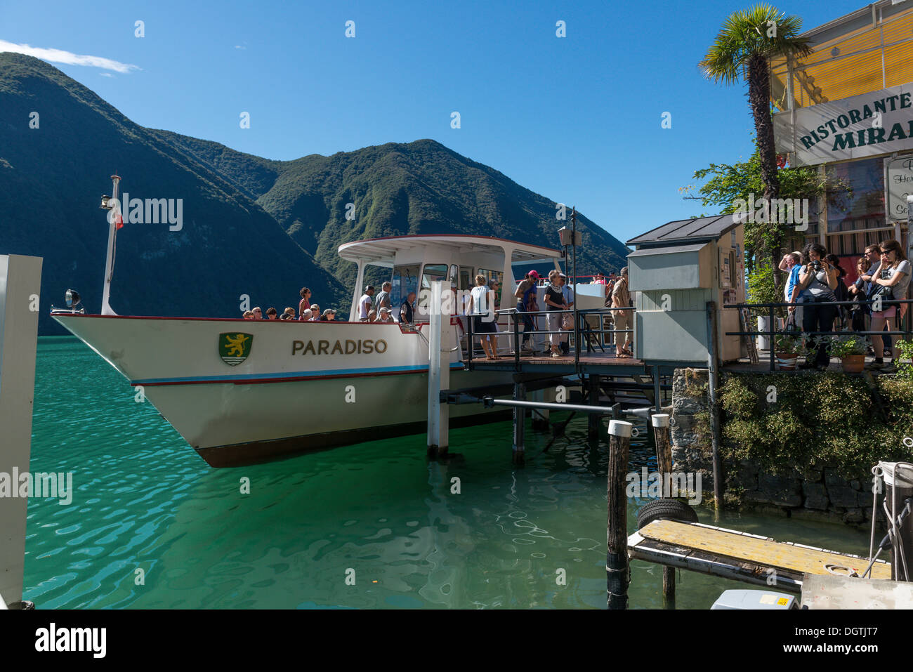 Passenger ferry boat arriving at the village of Gandria, Lake Lugano ...
