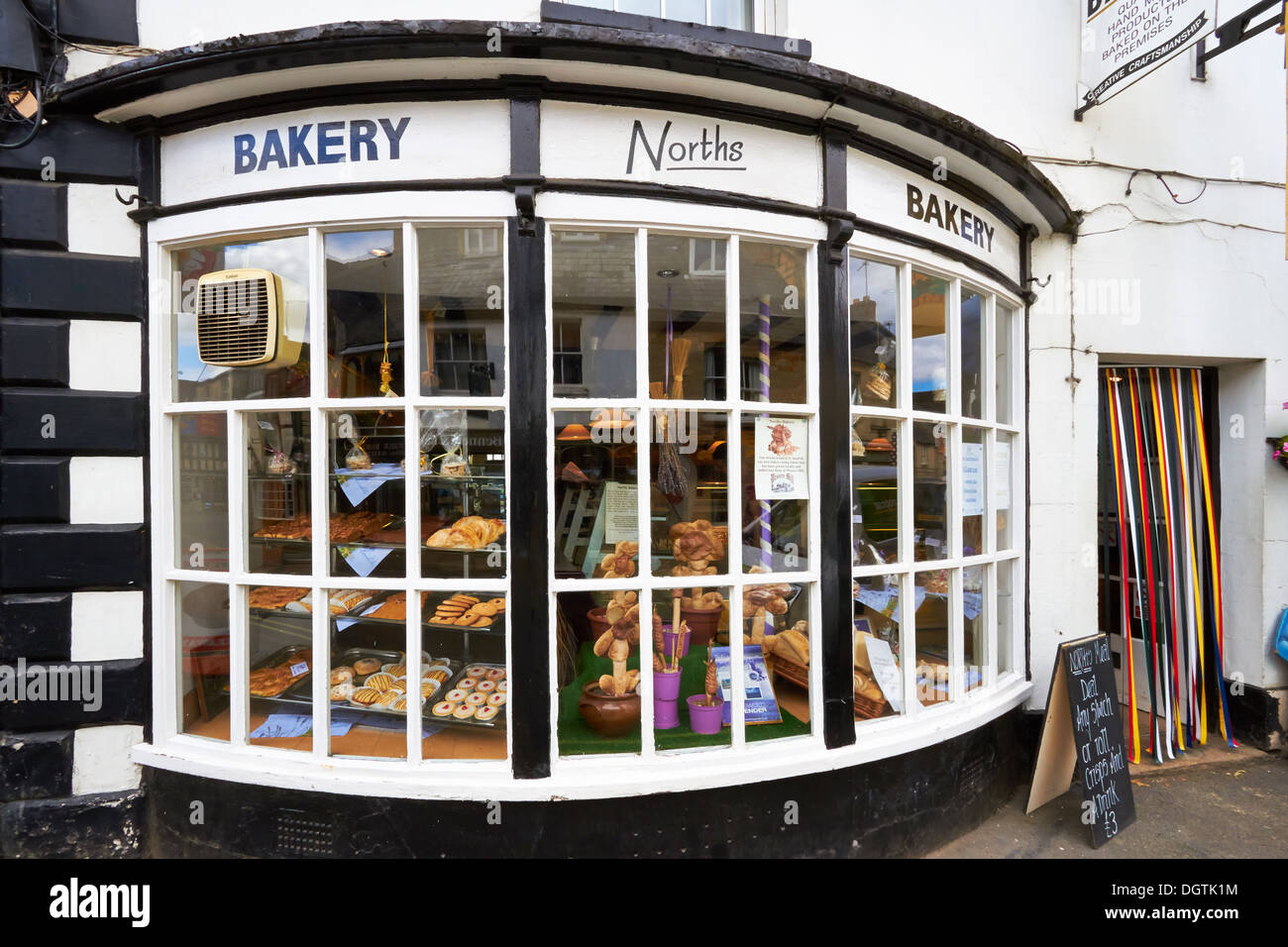Georgian bow window of a bakers shop in Winchcombe in the Cotswolds UK ...