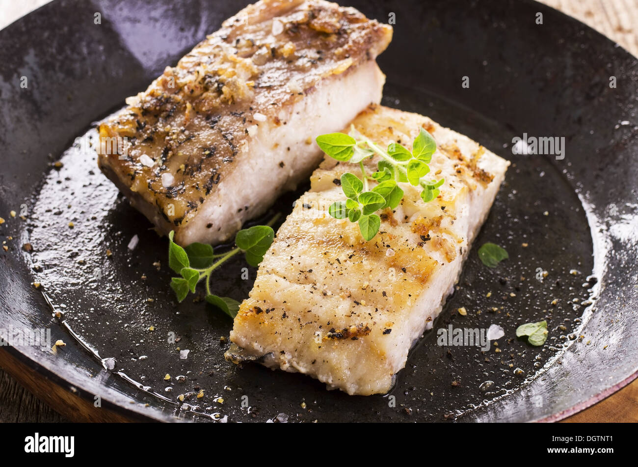 grouper fillet fried in the pan Stock Photo - Alamy
