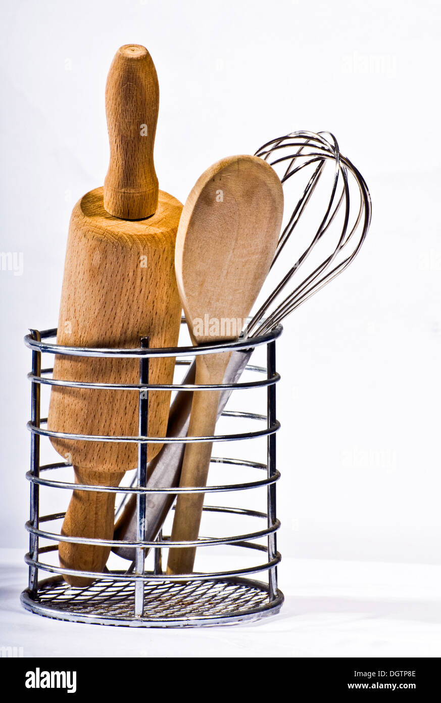 Kitchen utensils in a container on white background Stock Photo - Alamy