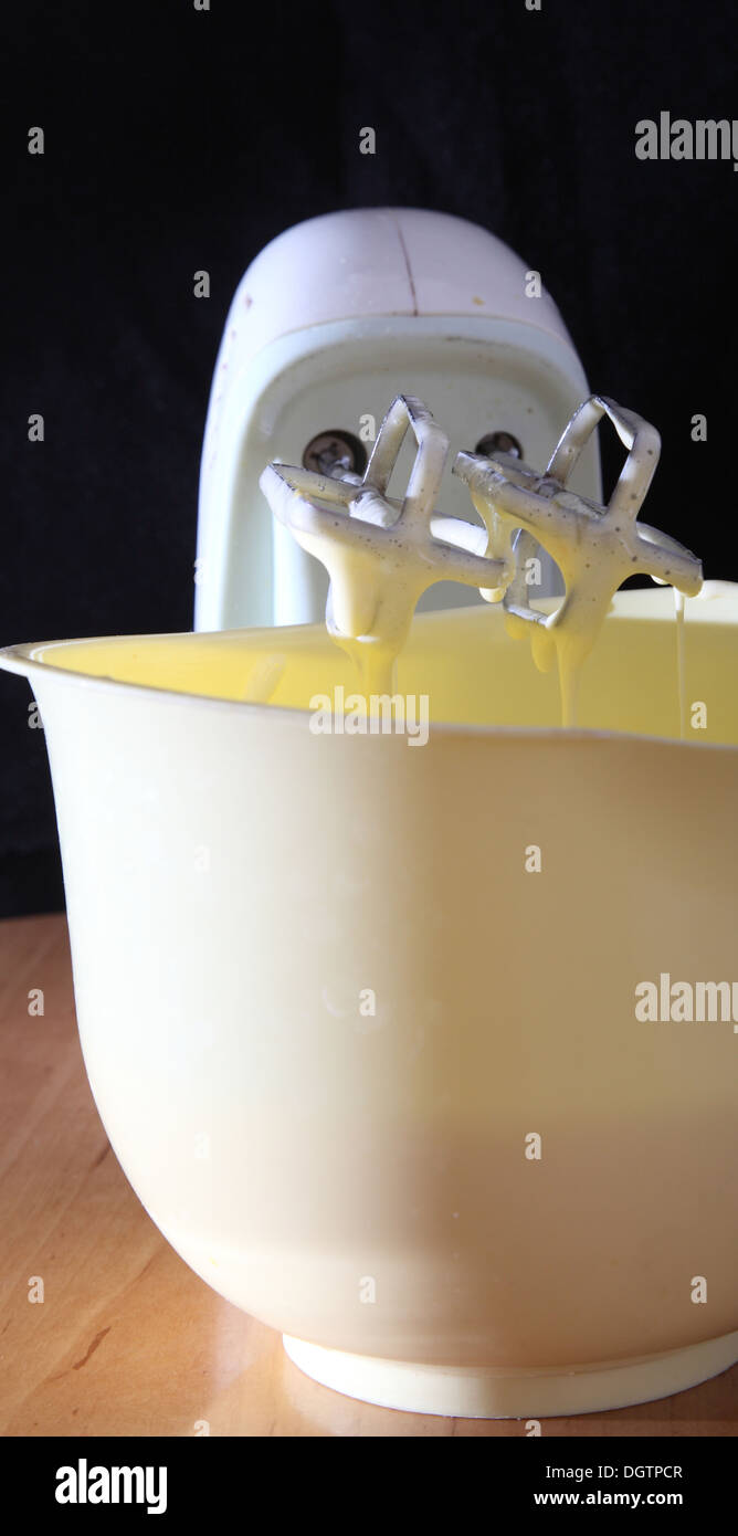 mixer and a yellow plate Stock Photo - Alamy