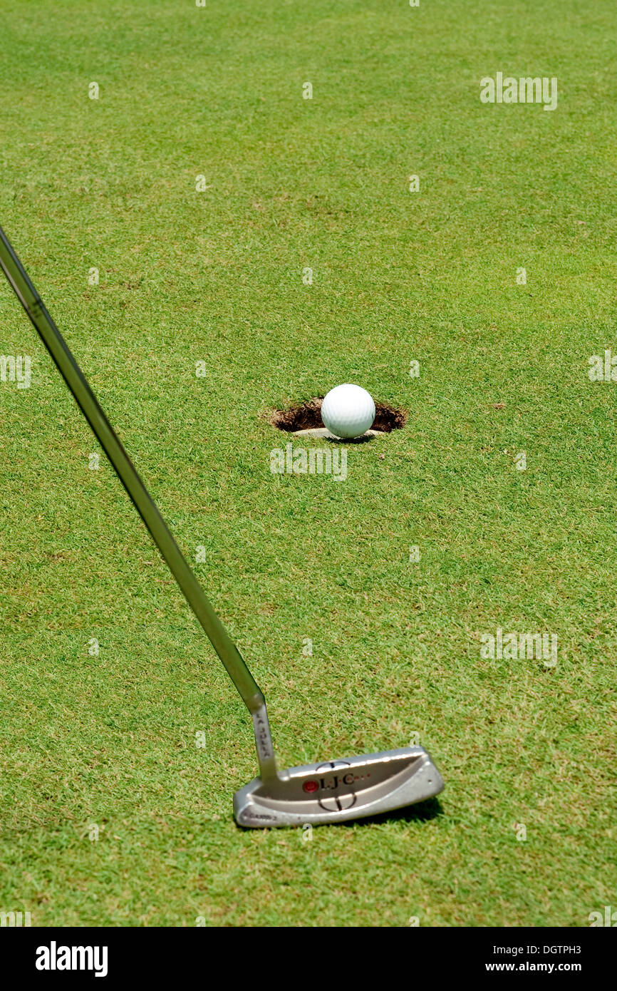 Golf ball next to the hole Stock Photo - Alamy