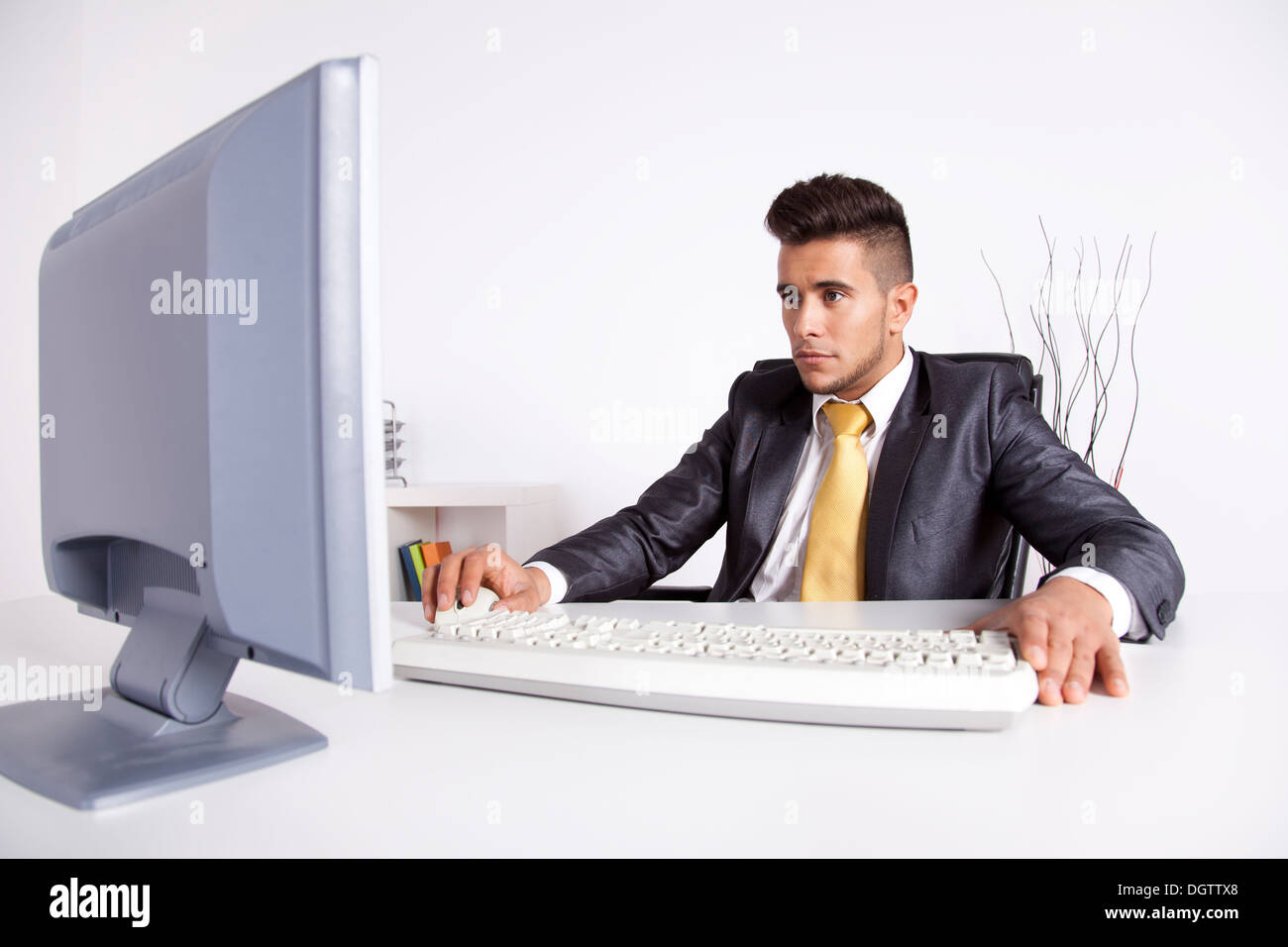 Businessman at his office using his desktop computer Stock Photo - Alamy
