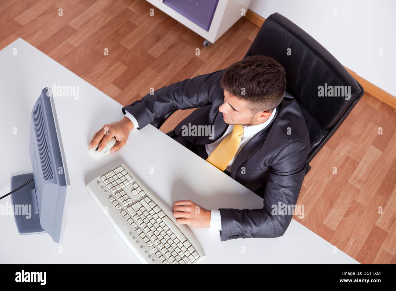 Businessman at his office using his desktop computer Stock Photo - Alamy