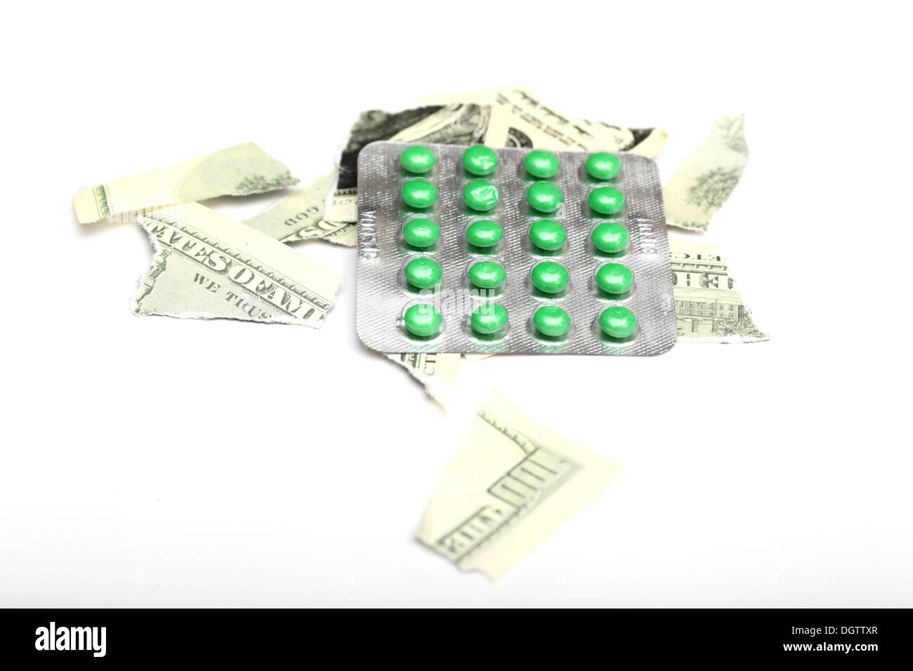 dollar bill torn to pieces and packaging for tablets Stock Photo - Alamy