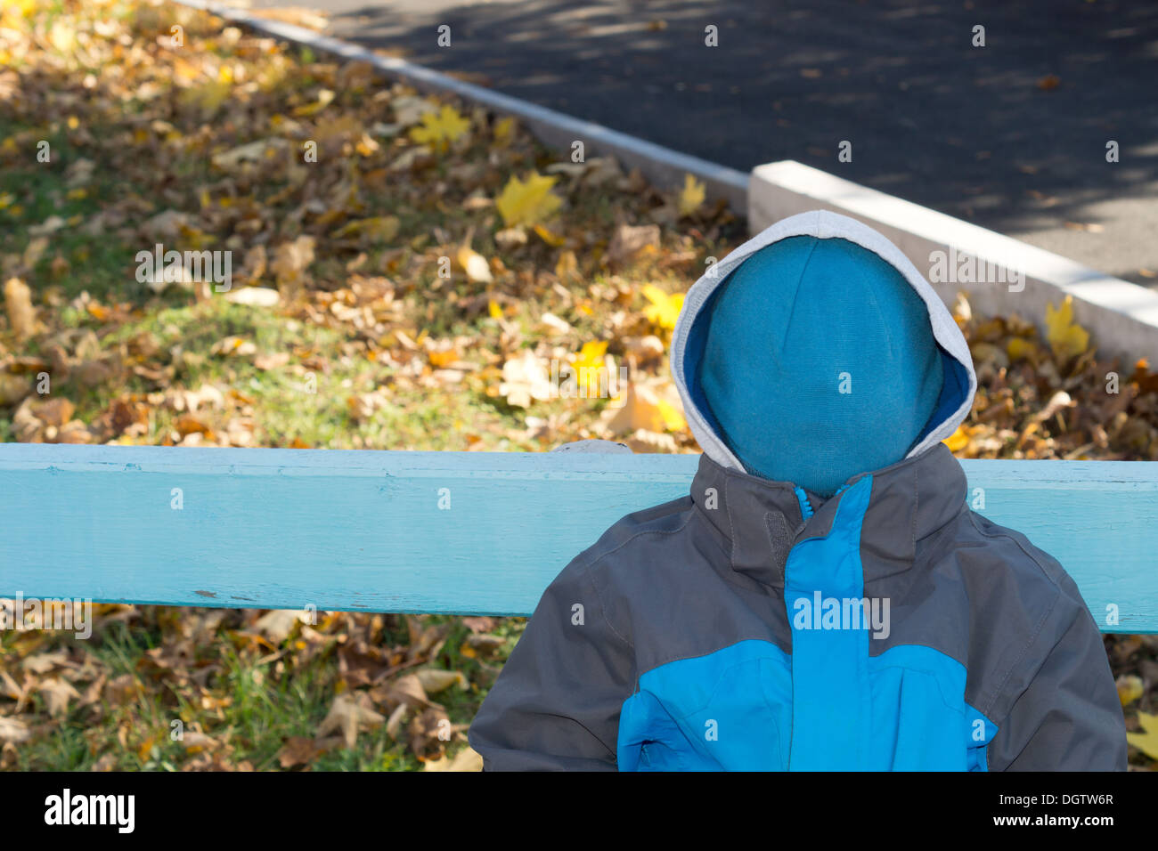 Faceless child having fun playing at being secretive and mysterious ...