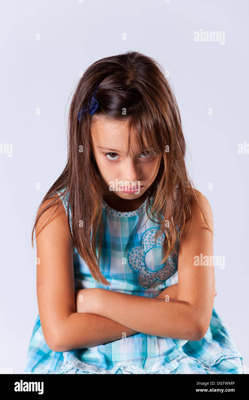 Upset expression from a little girl (isolated on gray Stock Photo - Alamy