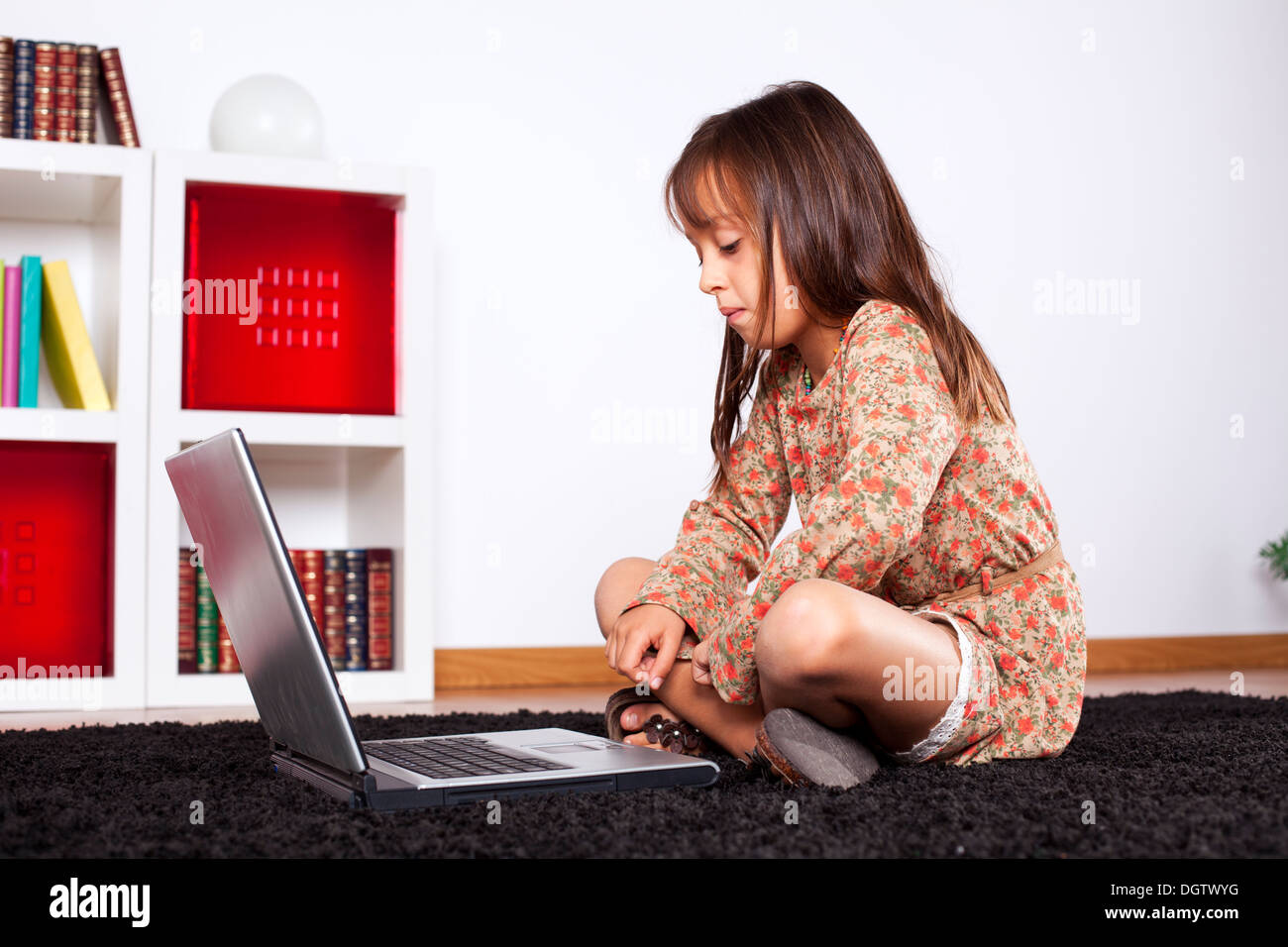 Little girl at her home using a laptop computer Stock Photo - Alamy