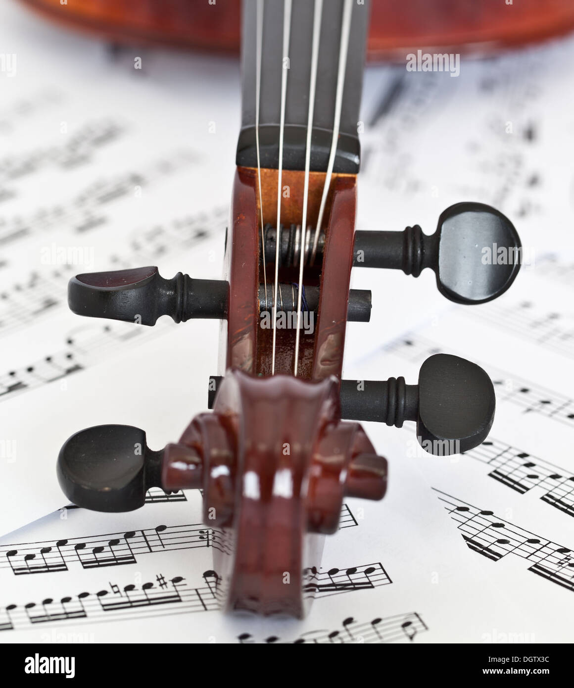 fiddle fingerboard on notes background Stock Photo - Alamy