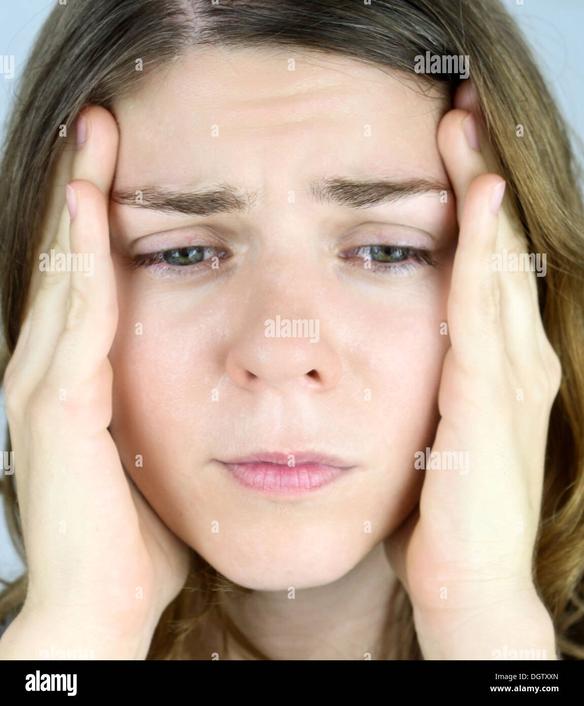 Young woman showing a painful expression Stock Photo - Alamy