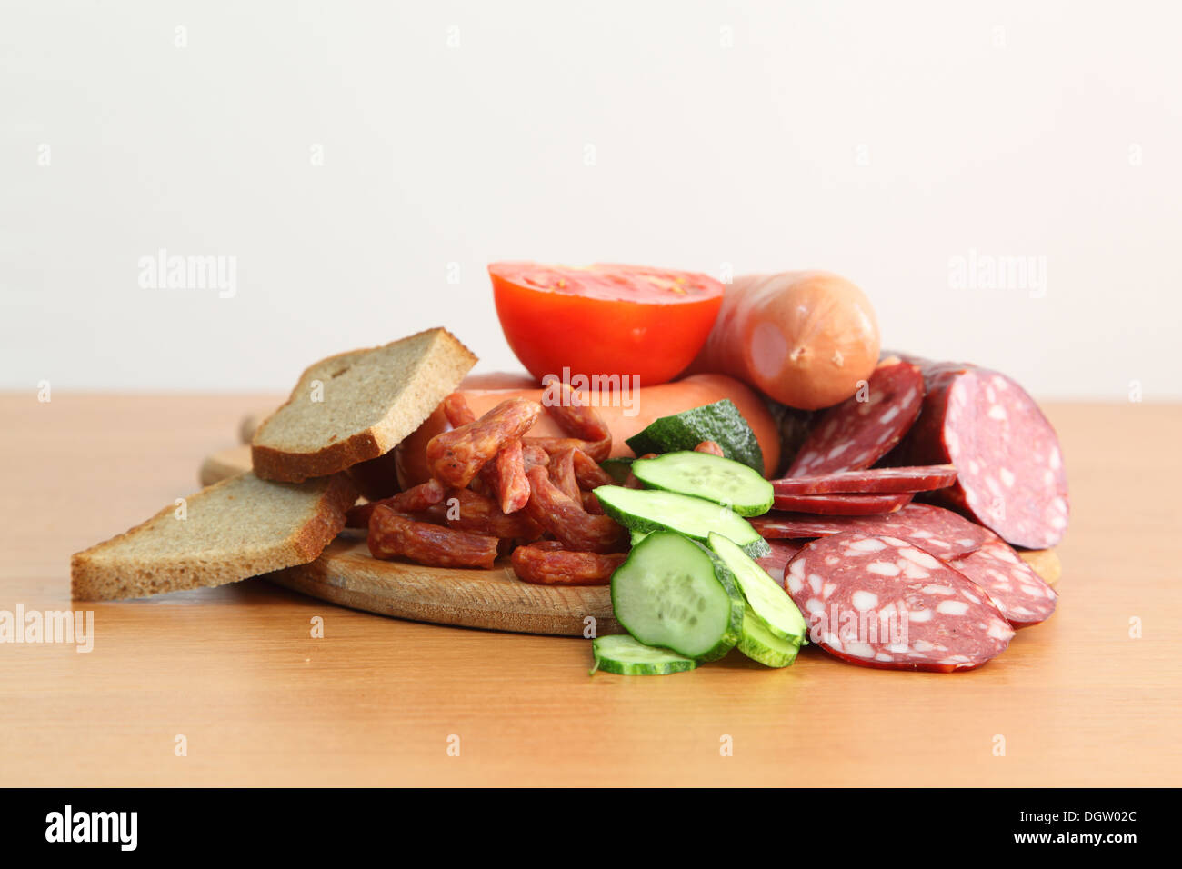 On the table of assorted cold cuts and bread cucumber and tomato Stock ...