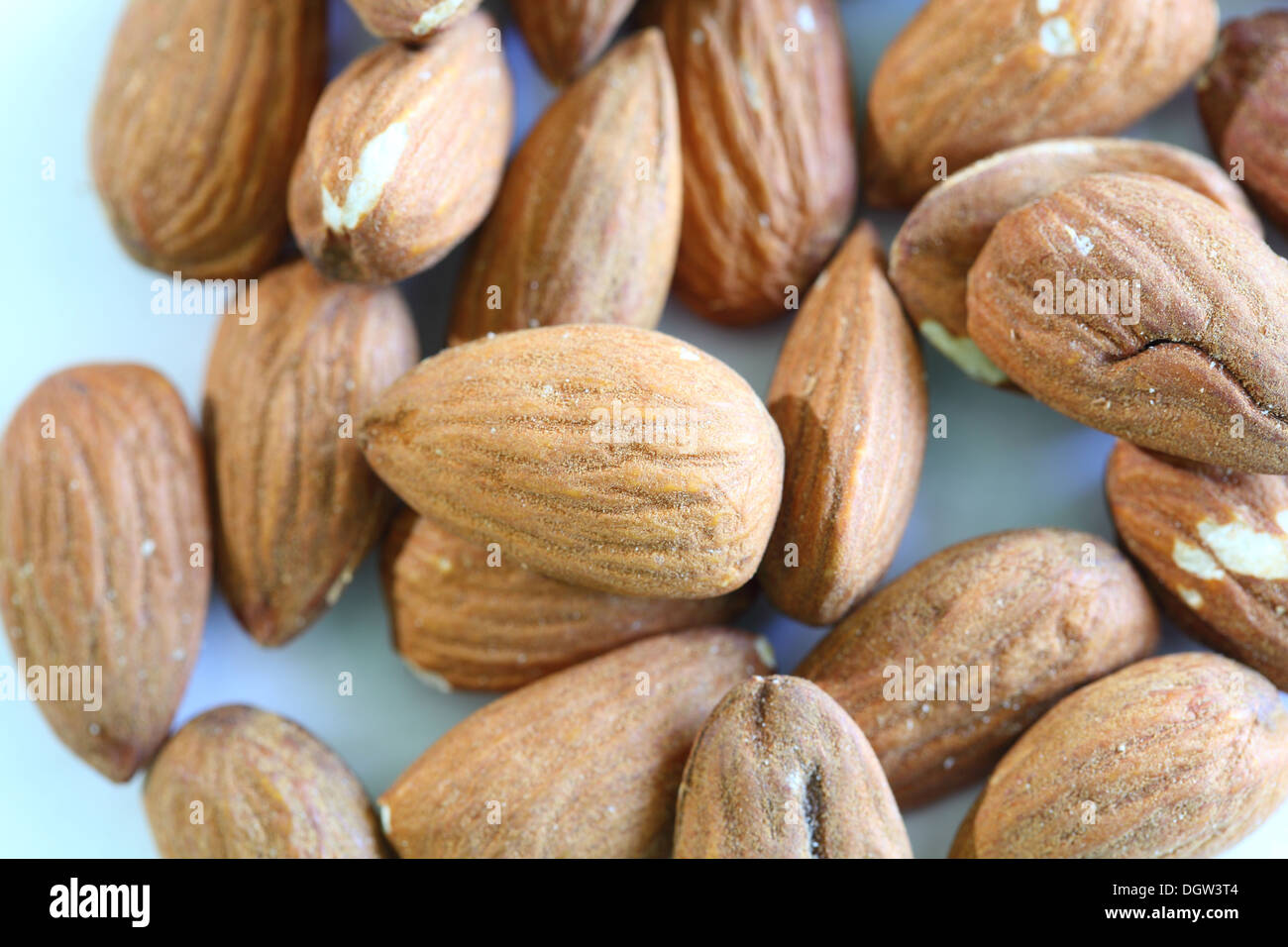 Almonds on a white background close-up Stock Photo - Alamy