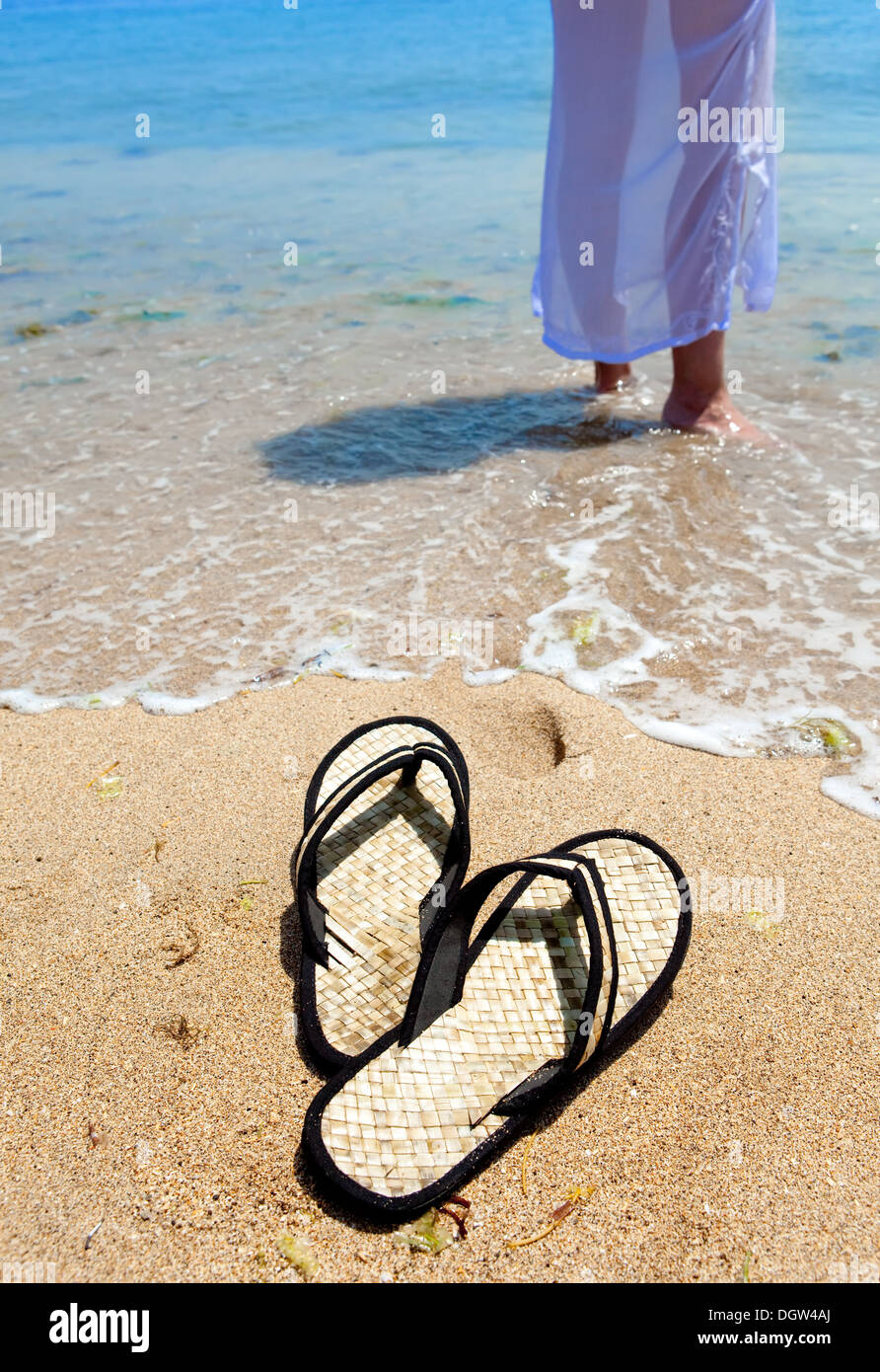 Beach slippers on sand Stock Photo - Alamy