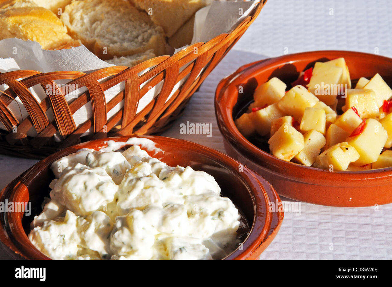 Spanish tapas of potato salad, bread and Manchego cheese with chillies ...