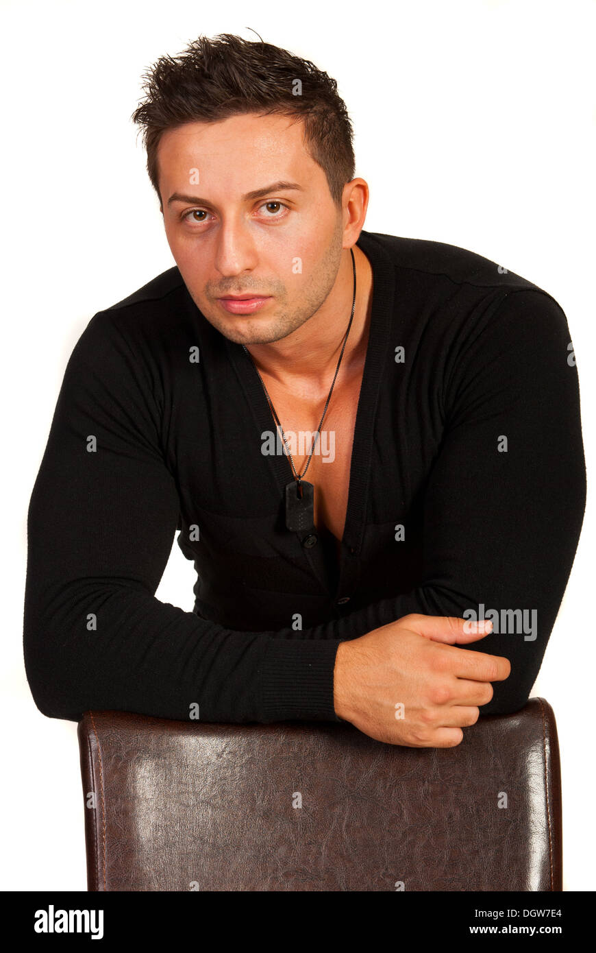 Fashionable guy resting hands on seat chair Stock Photo - Alamy