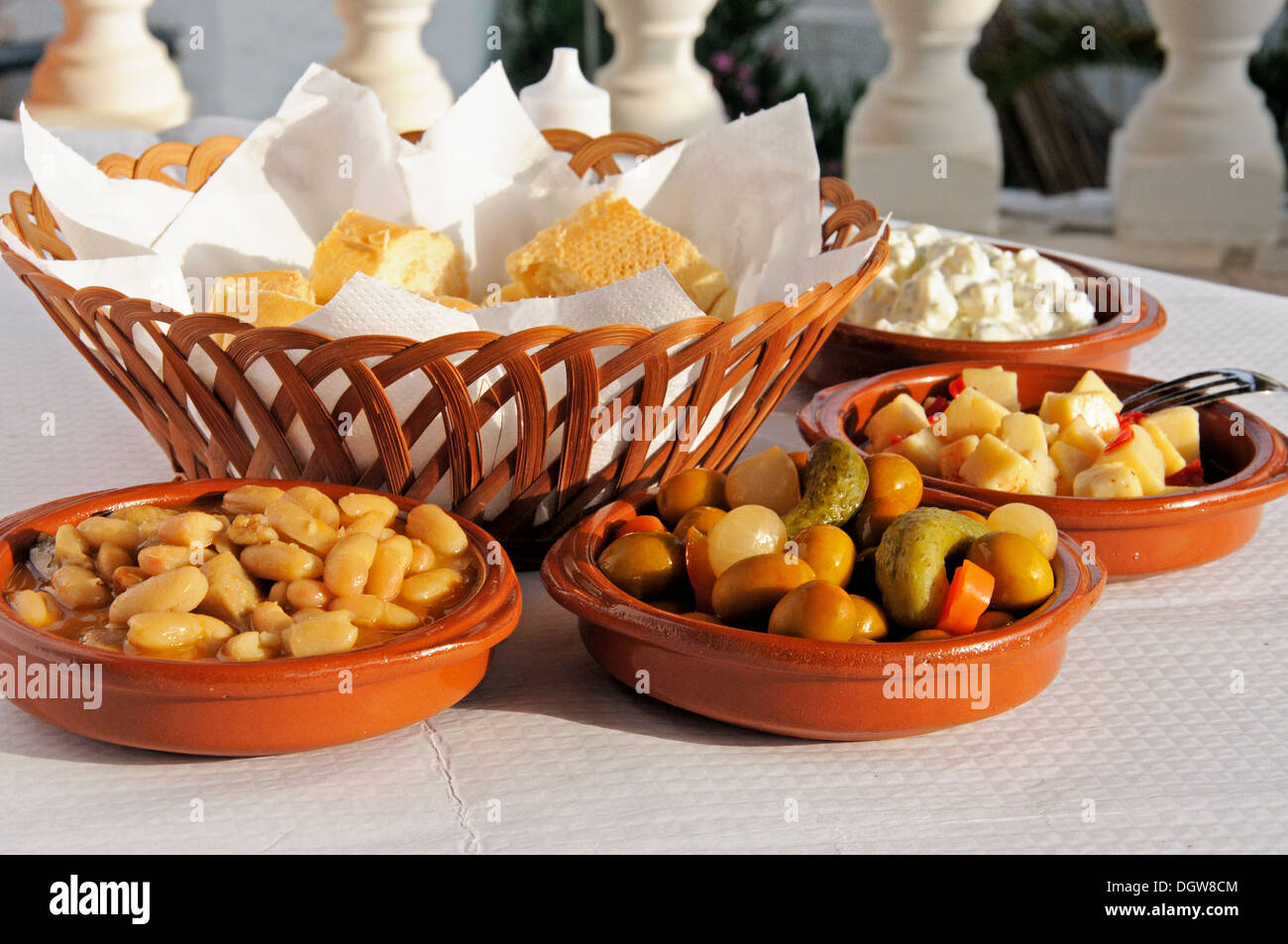 Spanish tapas of Beans with pork, Olive cocktail, Manchego cheese ...