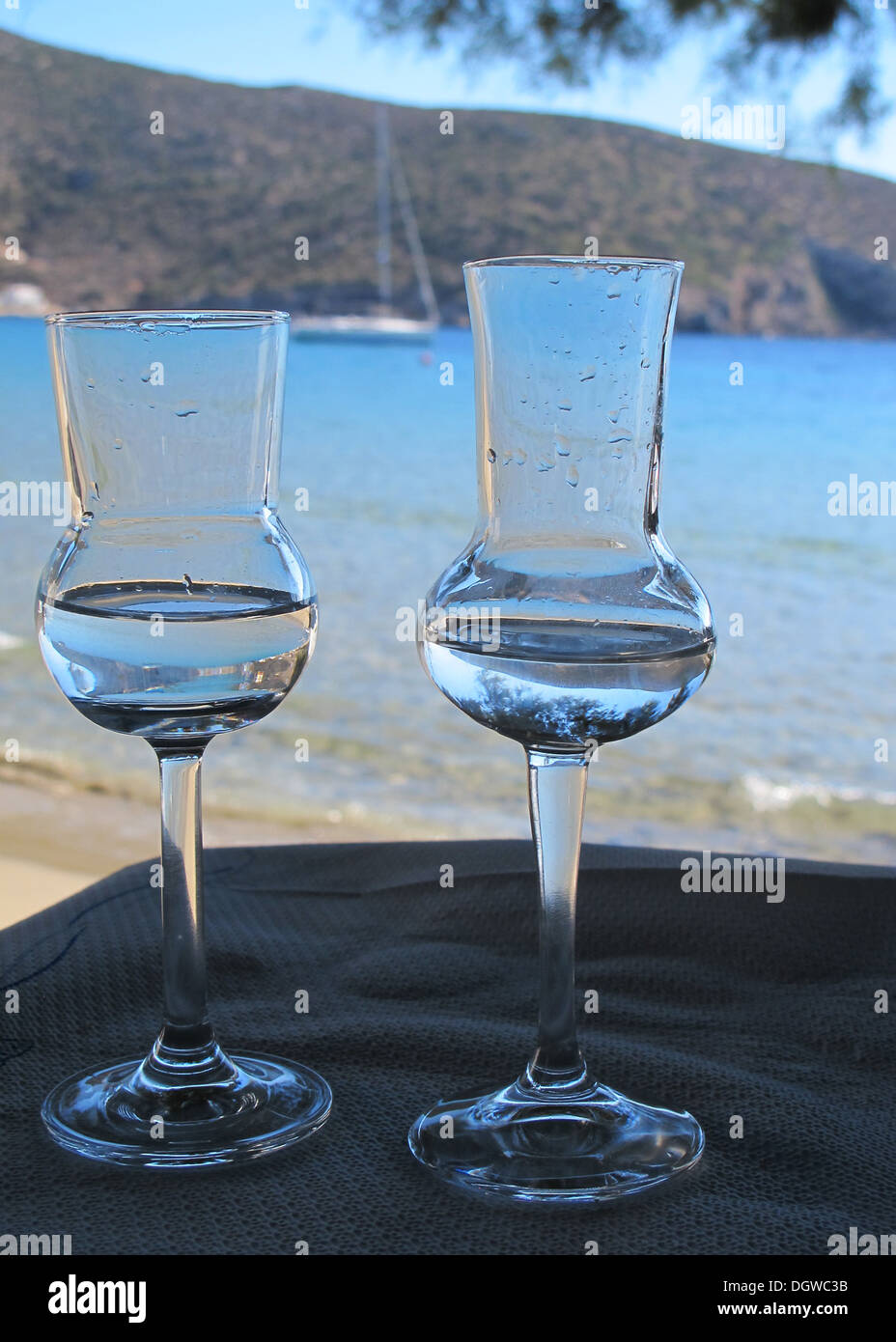 Mastika liqueur in two traditionally shaped glasses ending a meal on ...