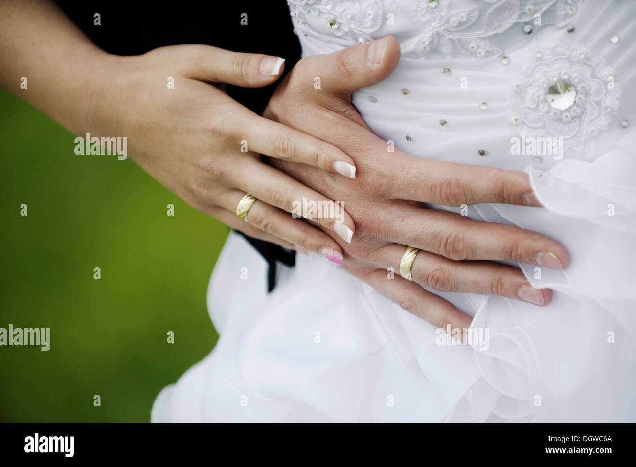 Wreathed hands of lovers. Hands of spouses being in the amorous touch ...