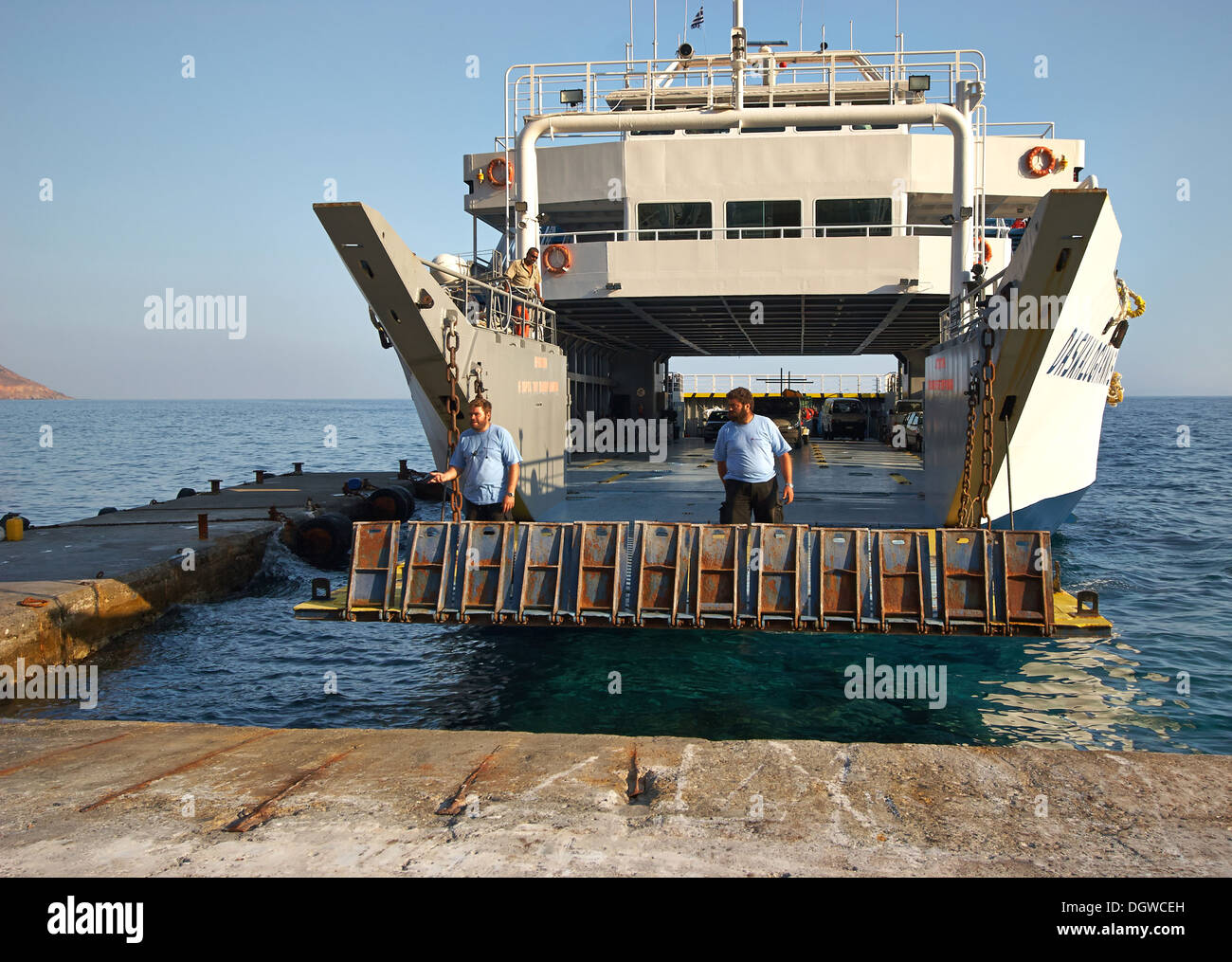 A Greek ferry lowers its bow doors and prepares to disembark at a ...