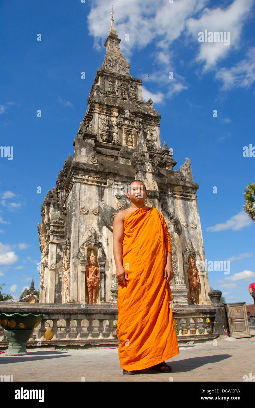 Theravada Buddhist, monk in orange robes, old ornate temple, That Ing ...