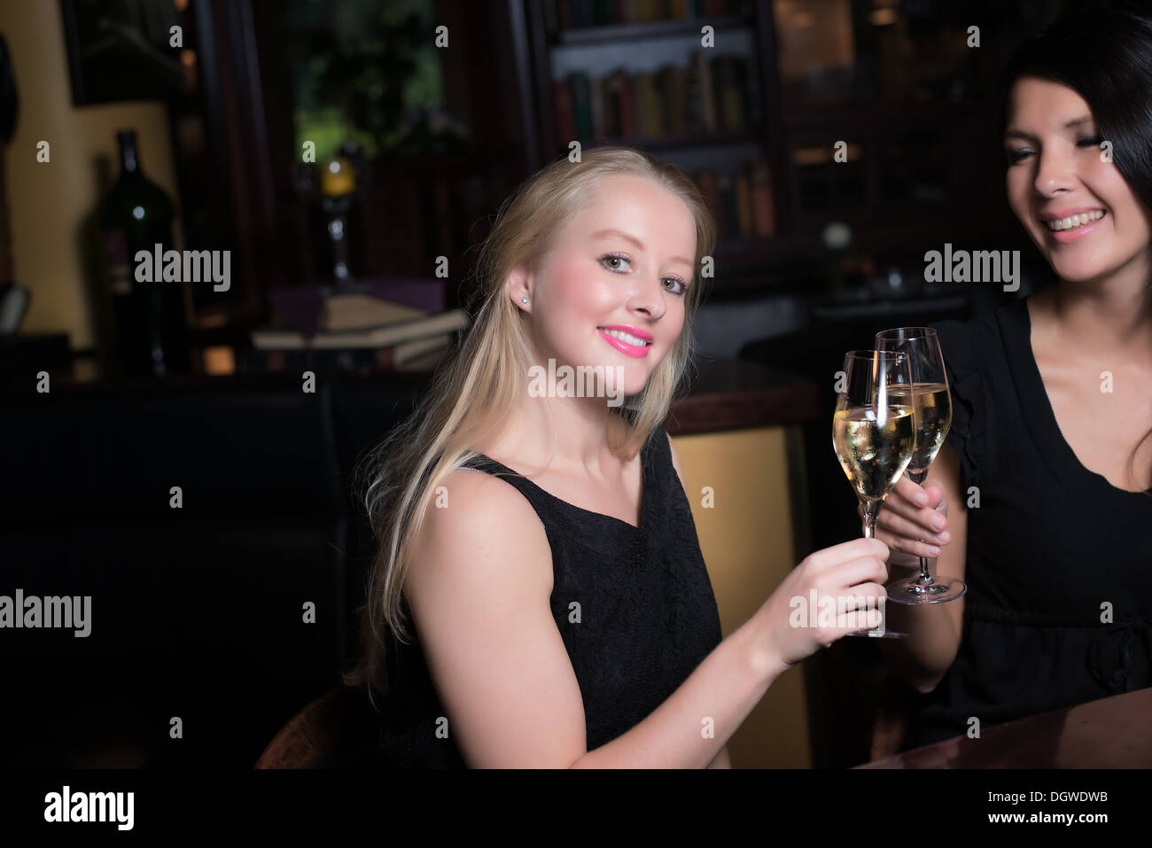 two beautiful women friends spending their evening in an elegant ...