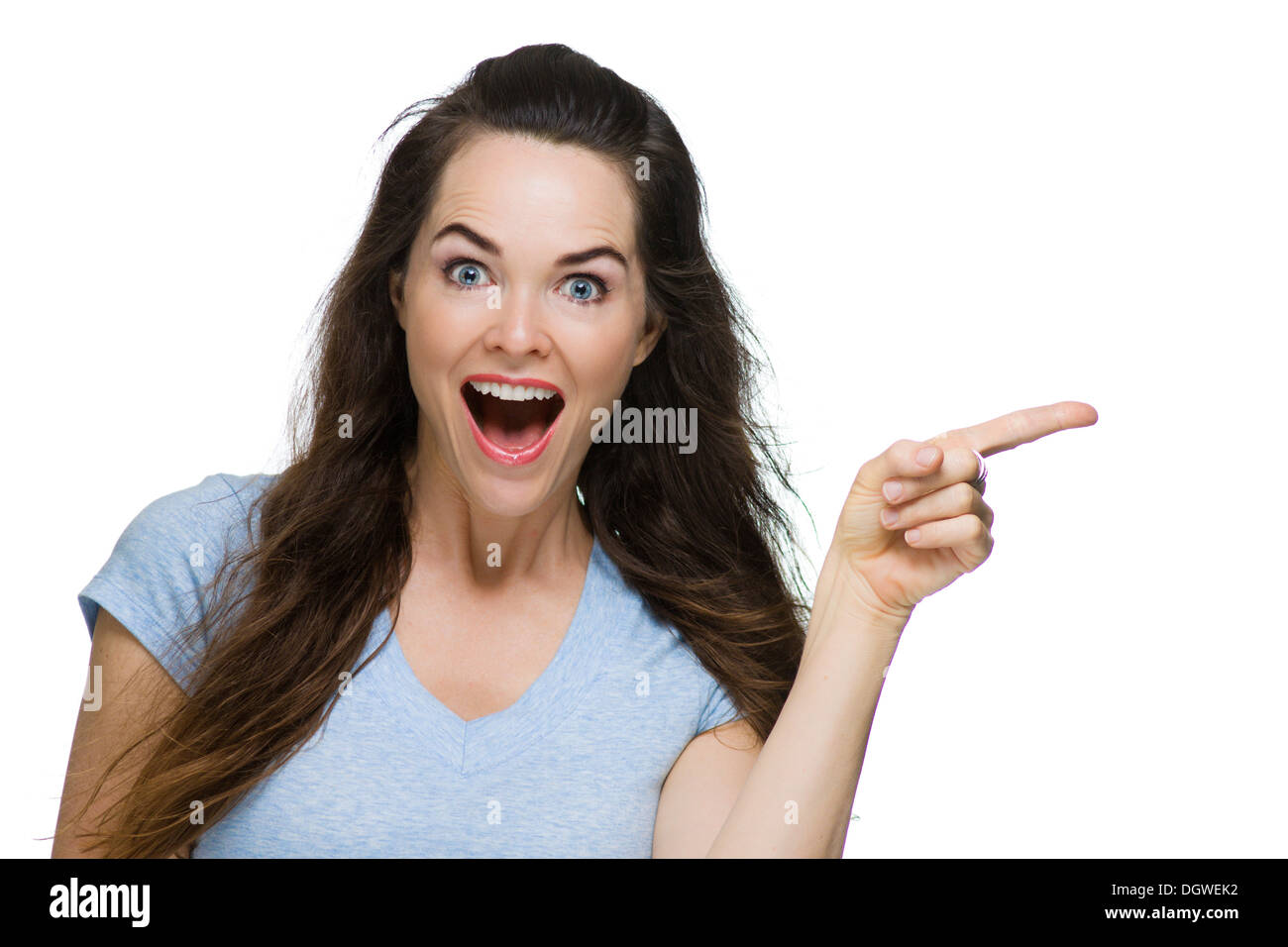 A very happy and surprised woman pointing to copy-space. Isolated on ...
