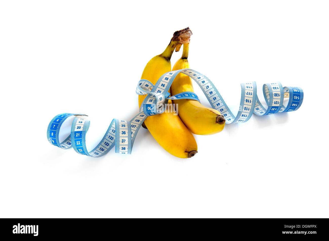 a banana with a tape-measure on a white background Stock Photo - Alamy