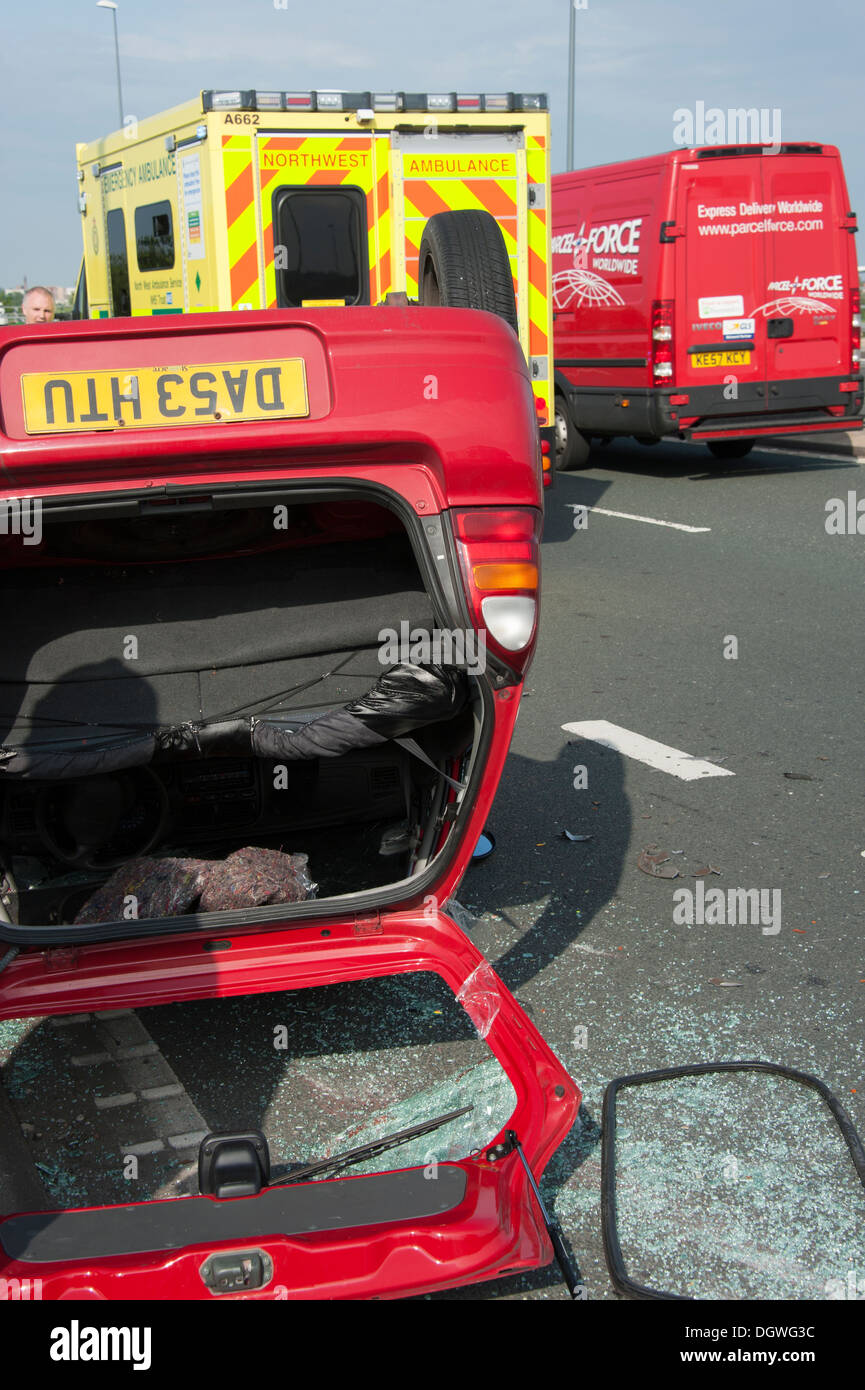 Car crash on roof overturned RTA RTC Fire Service Stock Photo - Alamy