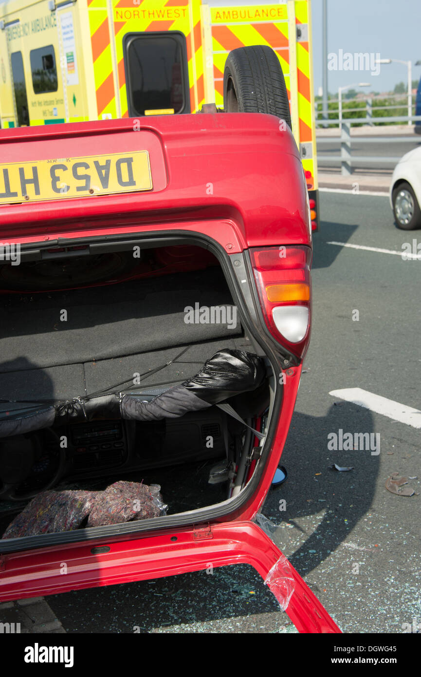 Car crash on roof overturned RTA RTC Fire Service Stock Photo - Alamy