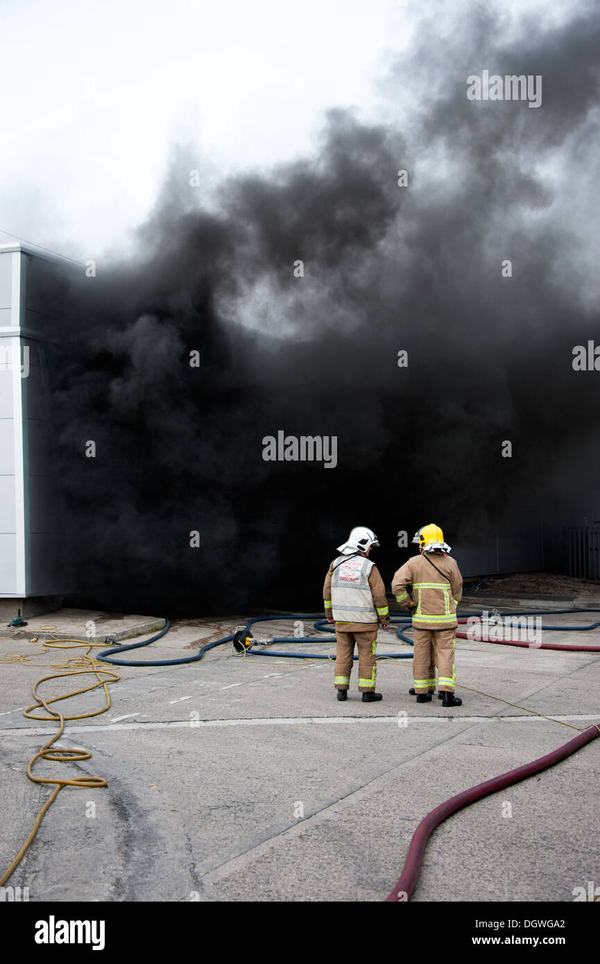 Two Firemen Firefighter black smoke factory fire Stock Photo - Alamy