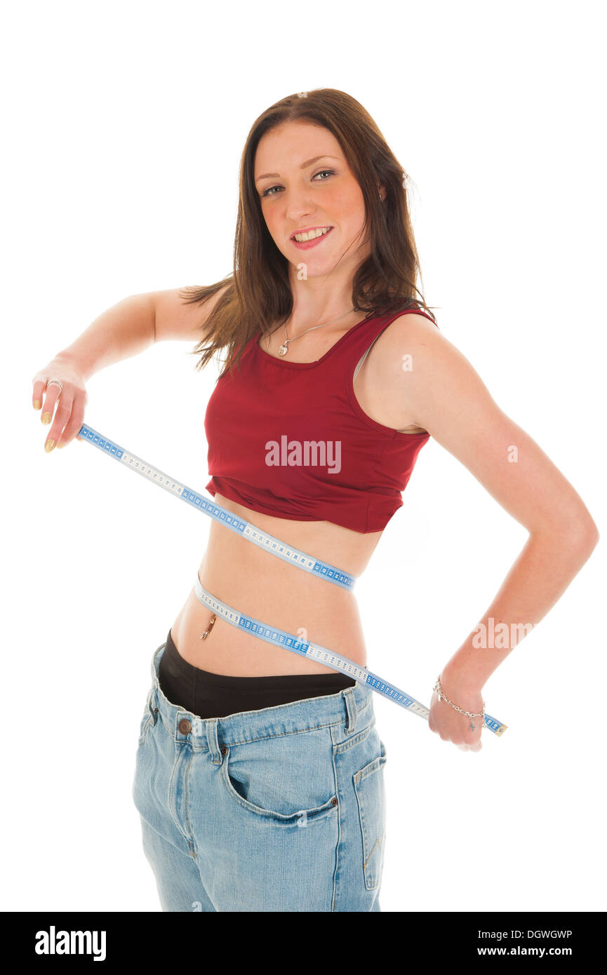 a girl with a measure tape, celebrating her success of loosing weight ...