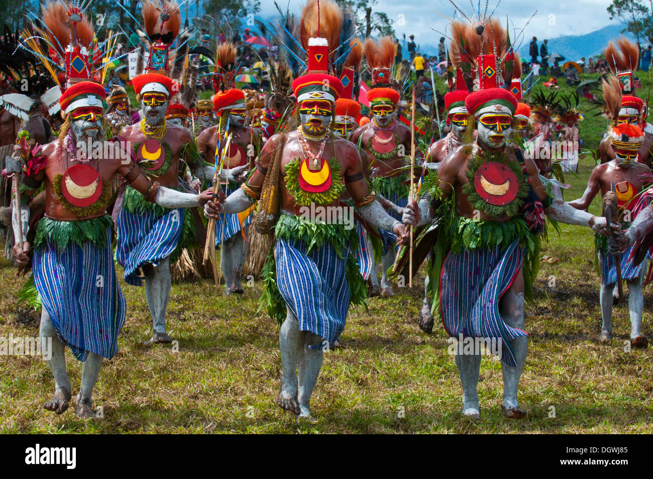 Members of a tribe in colourfully decorated costumes with face paint at ...
