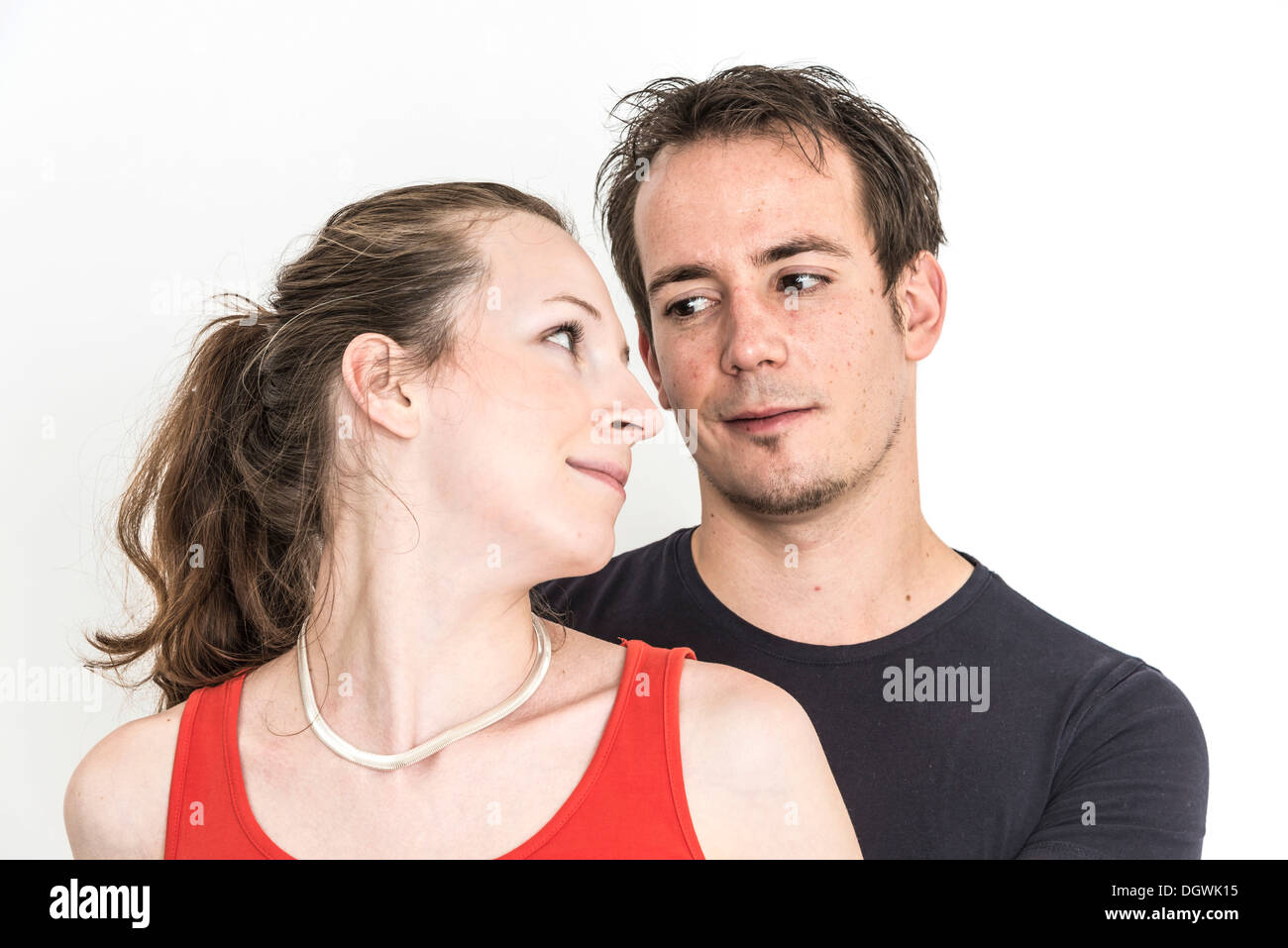 Couple looking each other in the eye, woman standing in front of a man ...